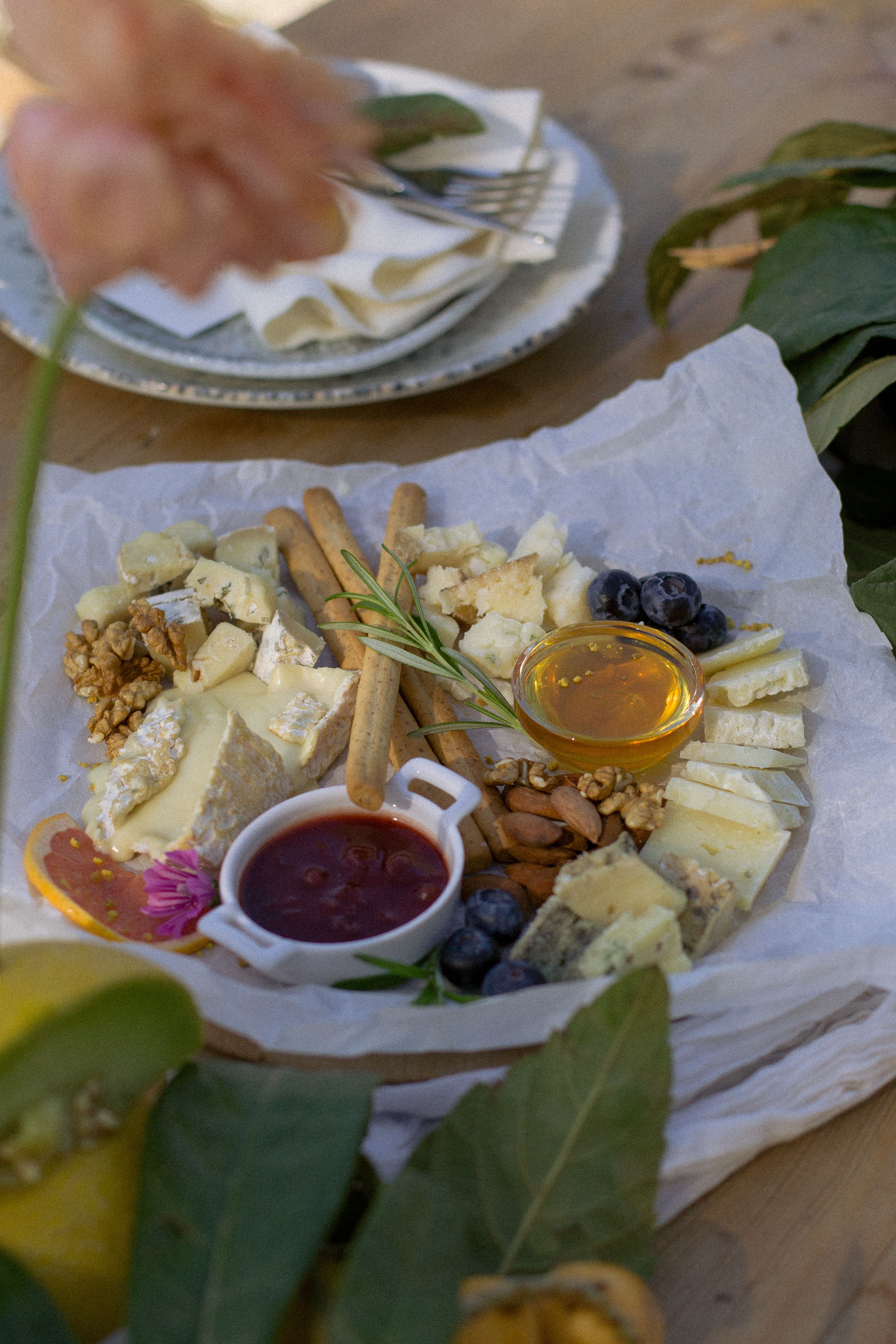 Close-up of a Plate with Cheese, Nuts and Breadsticks on a Table · Free ...