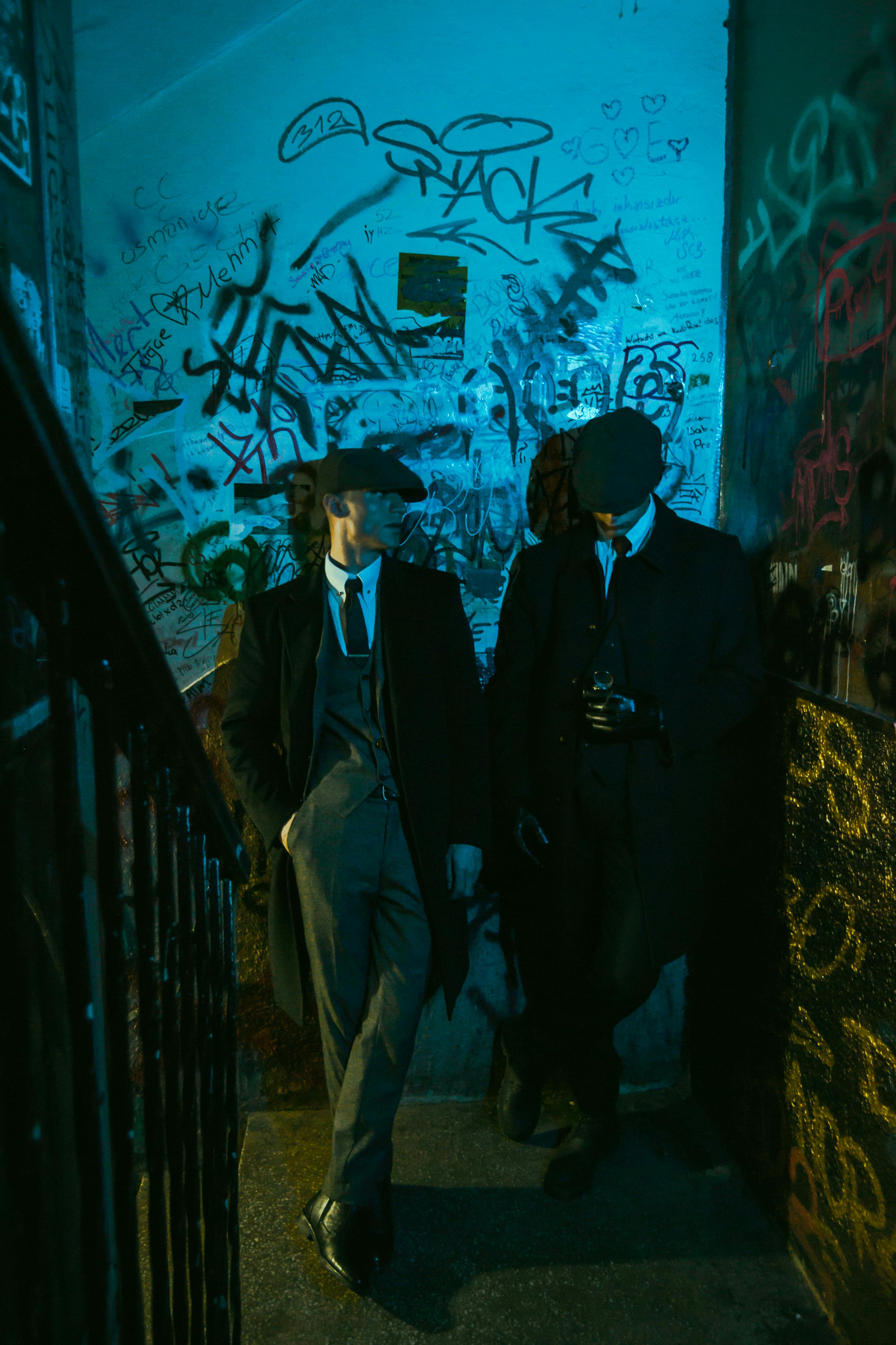 Men Wearing Hat and Coat in Shadow · Free Stock Photo