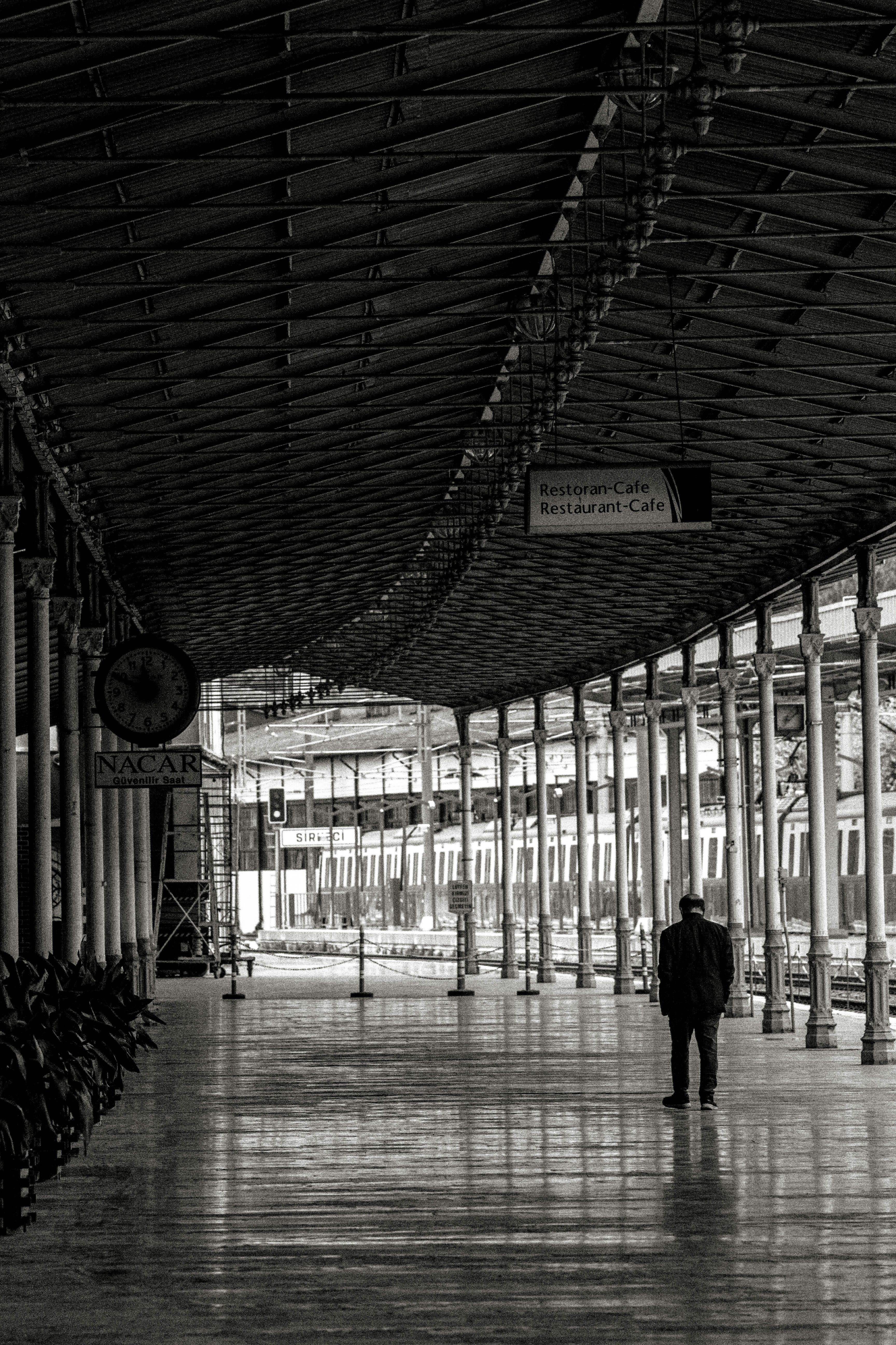 Man Standing Alone at Railway Station Platform · Free Stock Photo