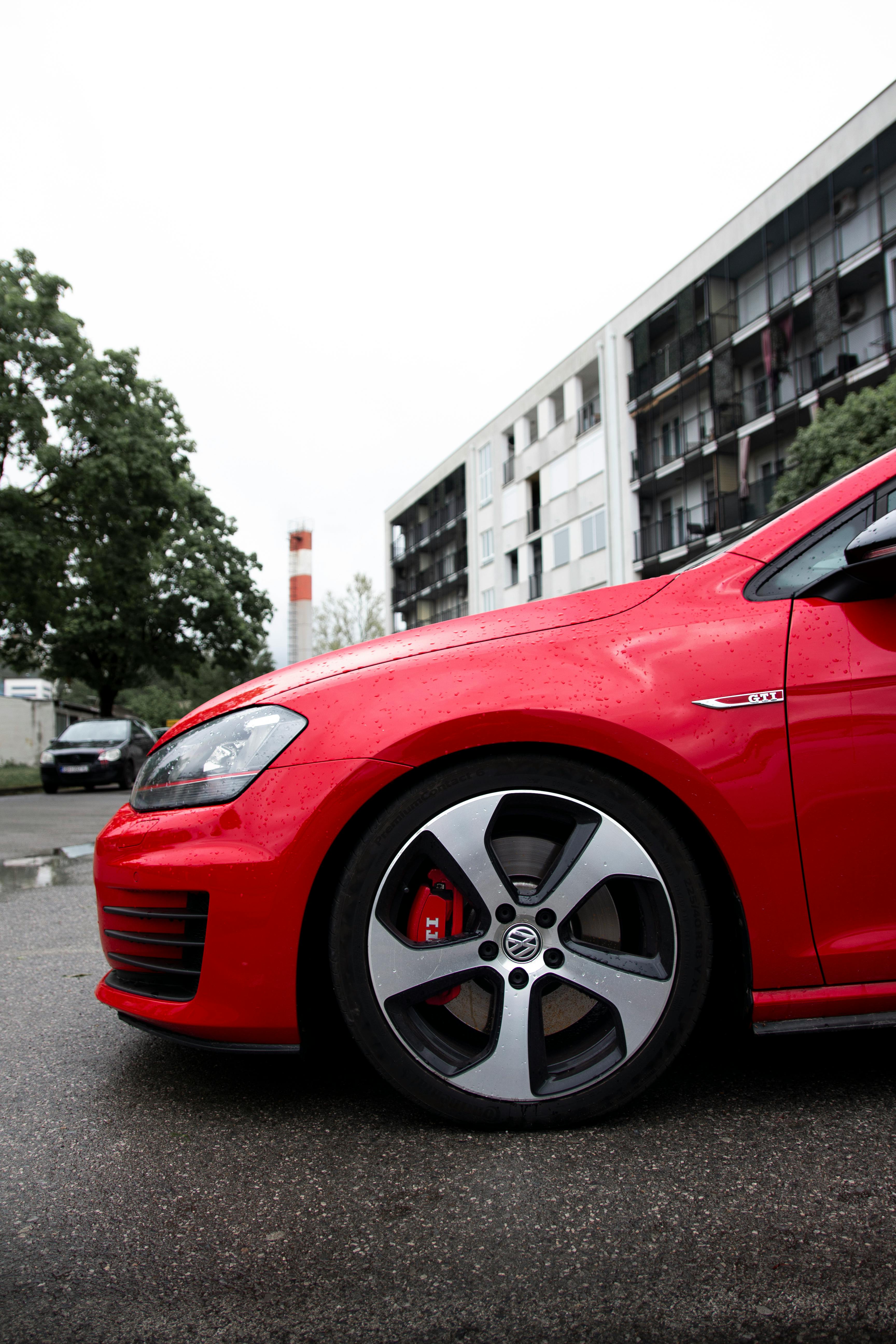 Side View of a Red Volkswagen Golf VII on a Street · Free Stock Photo