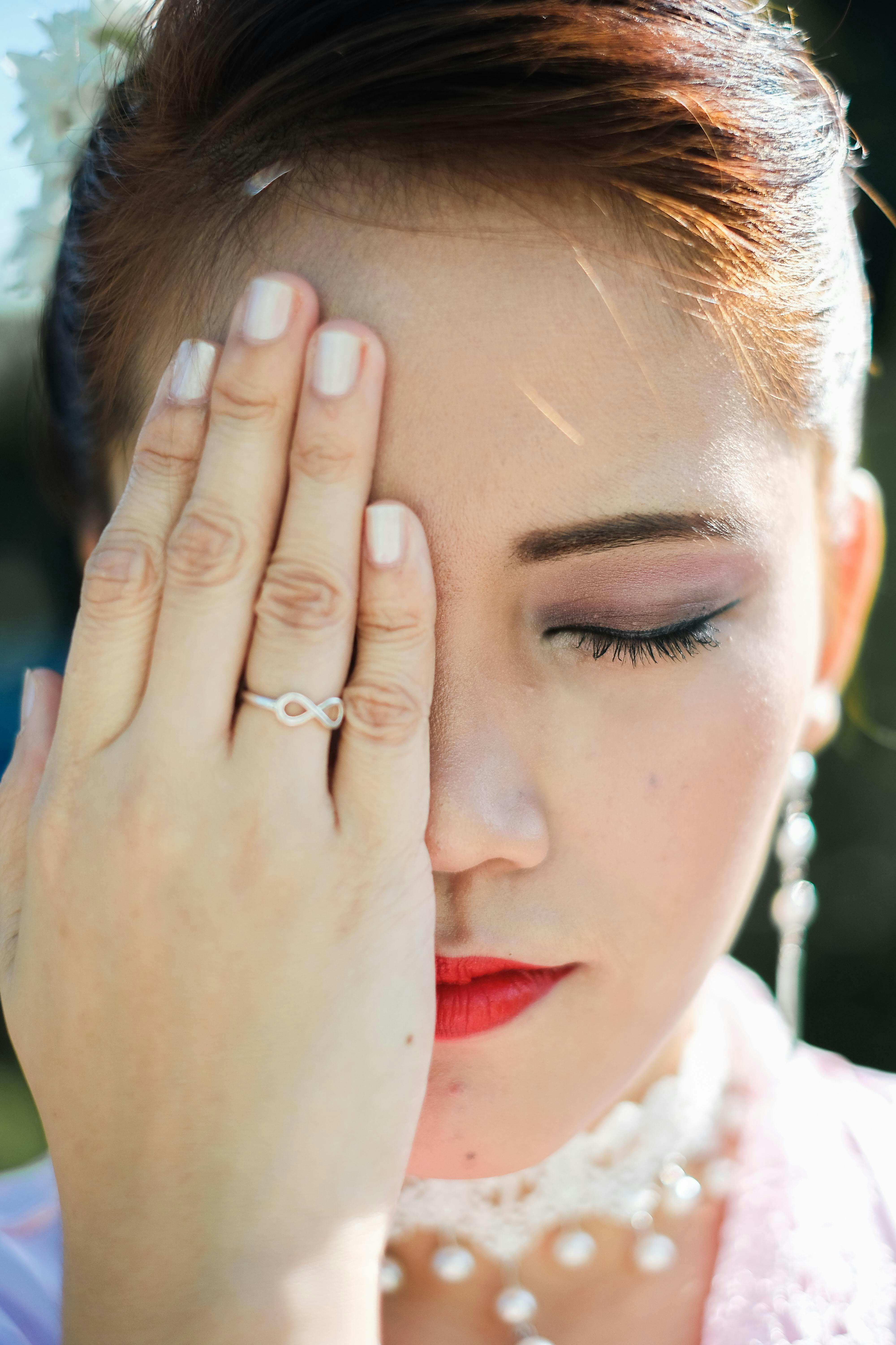 Woman Covering Her Right Eye With Her Right Hand · Free Stock Photo