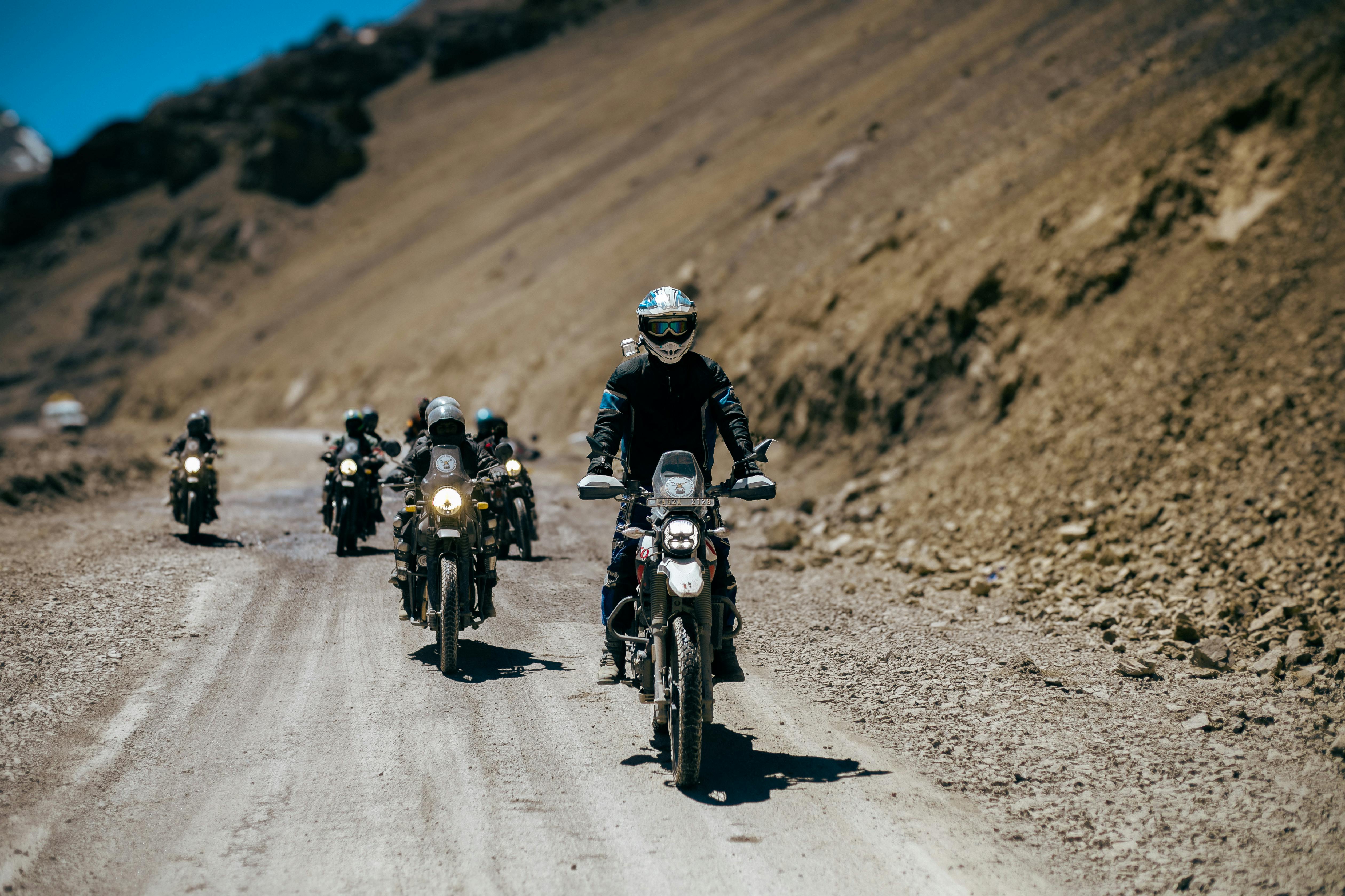 Group of Motorcyclists on Dirt Road · Free Stock Photo