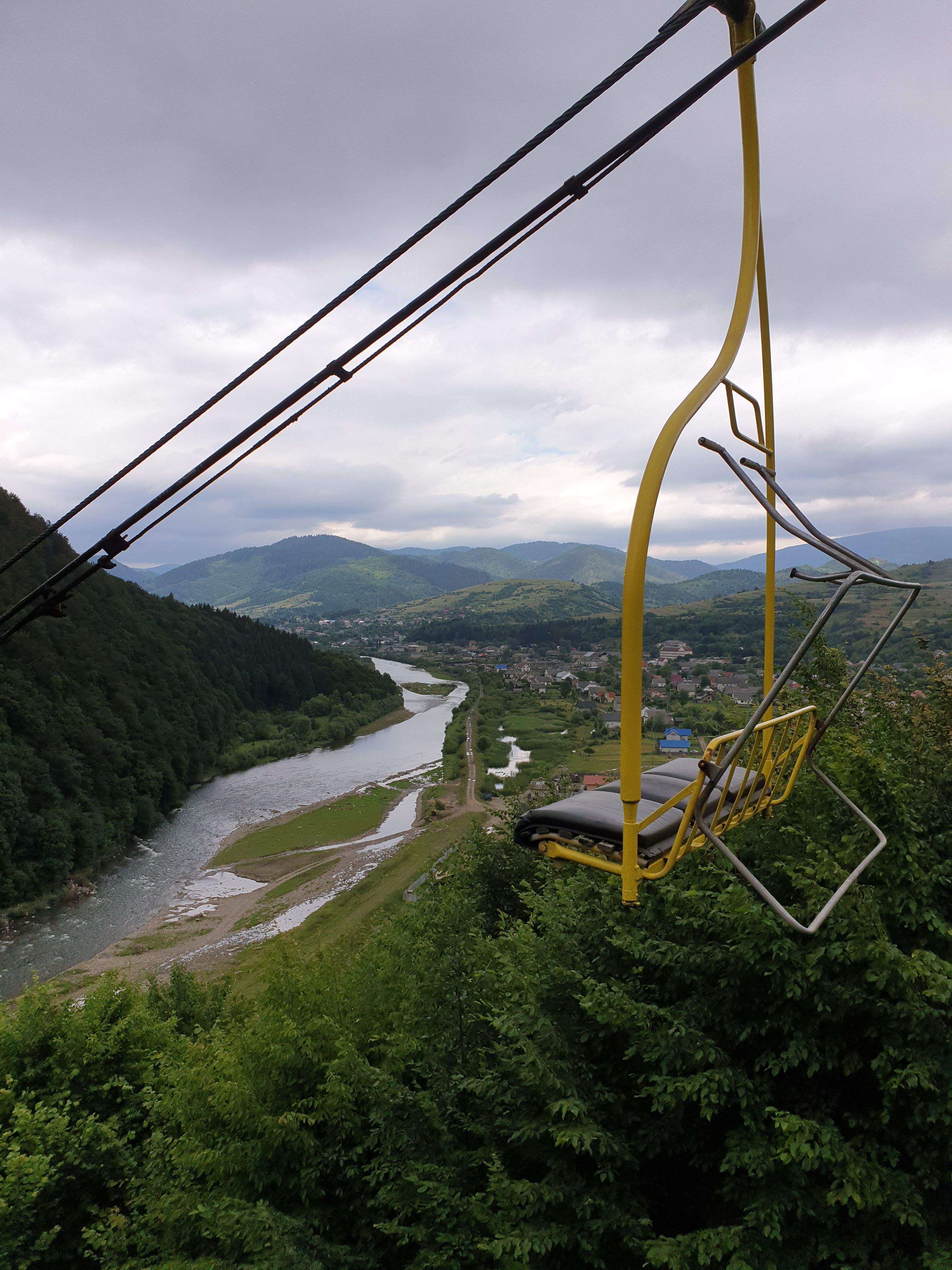 A chair lift with a view of a river · Free Stock Photo
