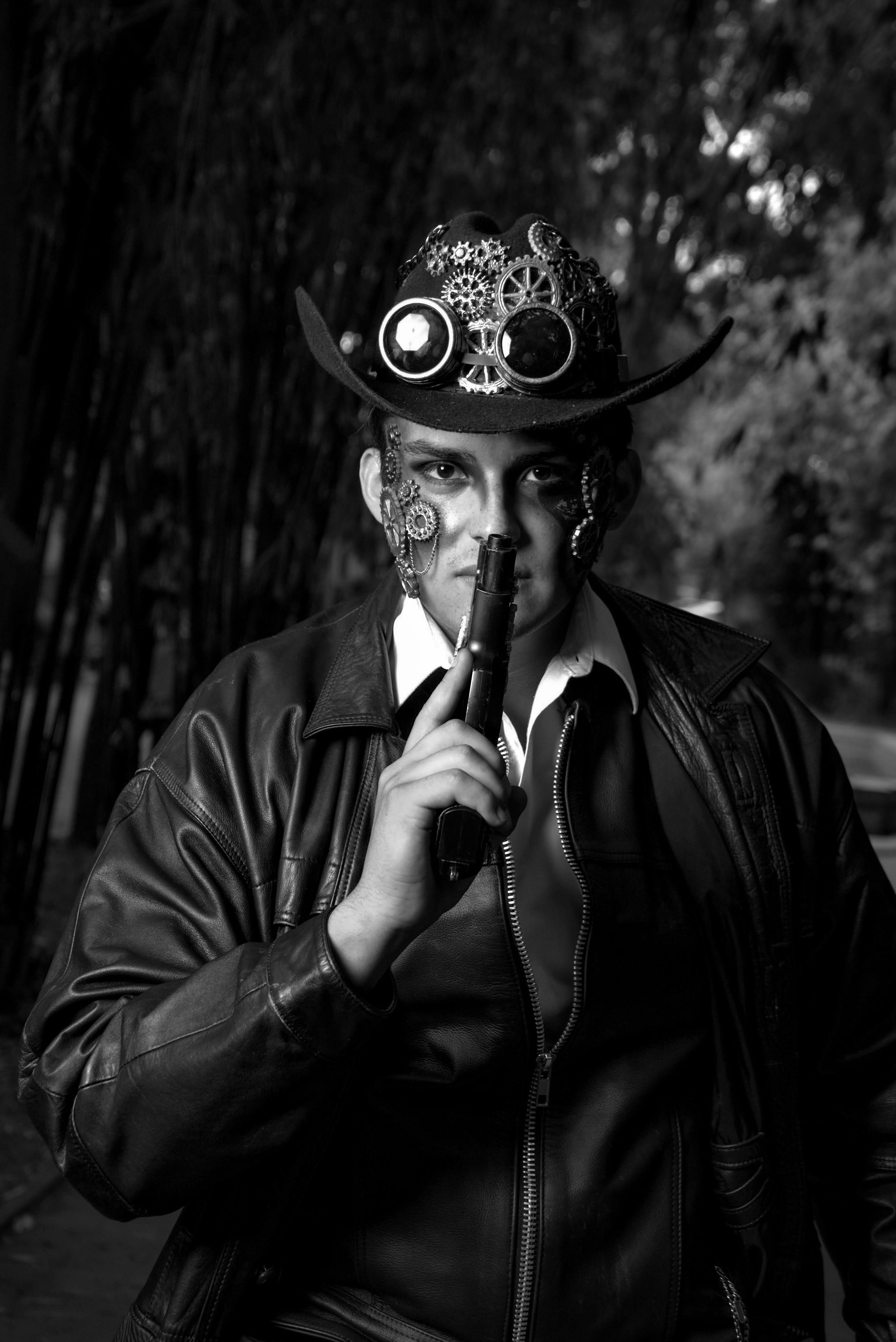 Performer in Steampunk Costume Holding a Gun · Free Stock Photo