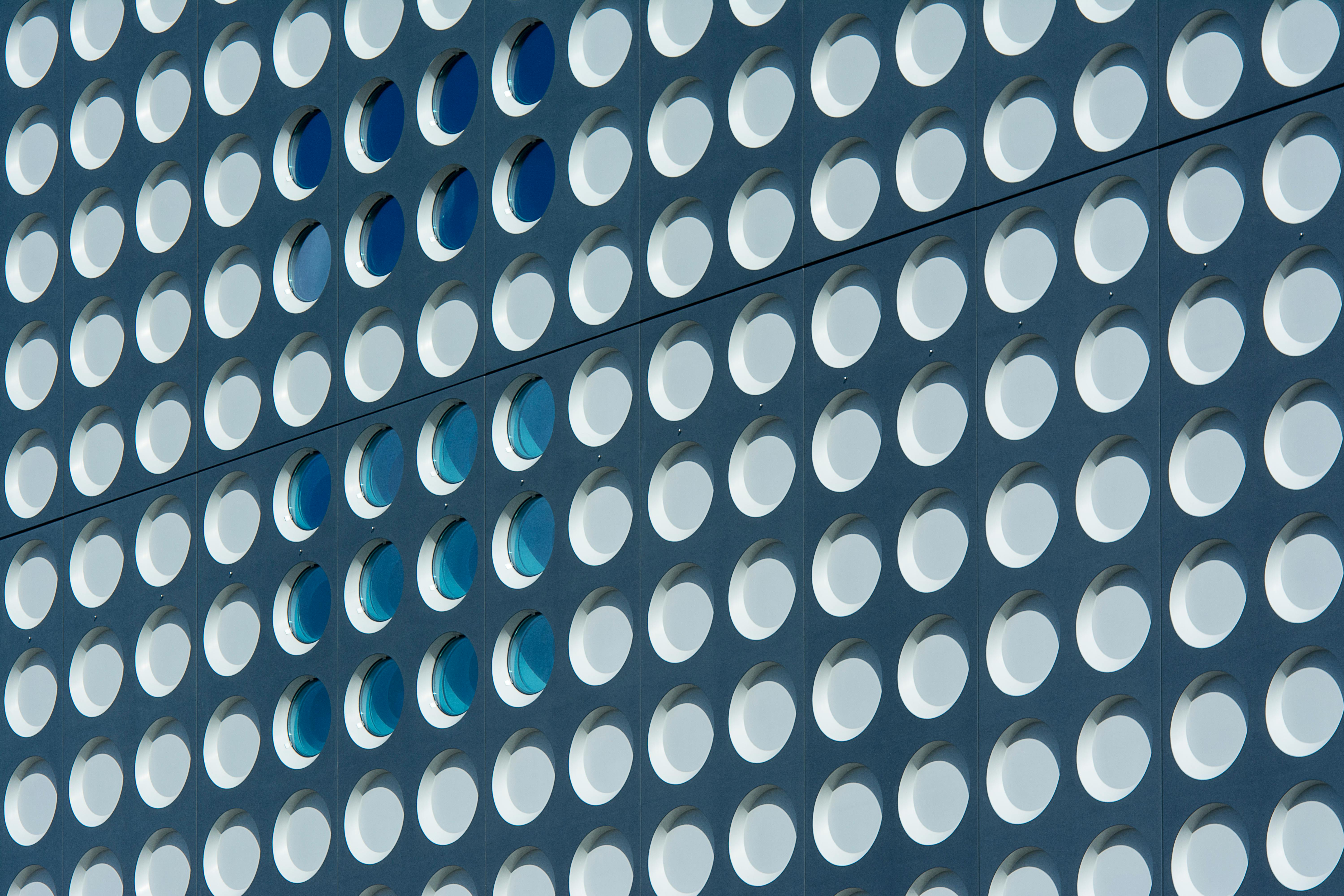 Circular Holes in Buildings Wall · Free Stock Photo
