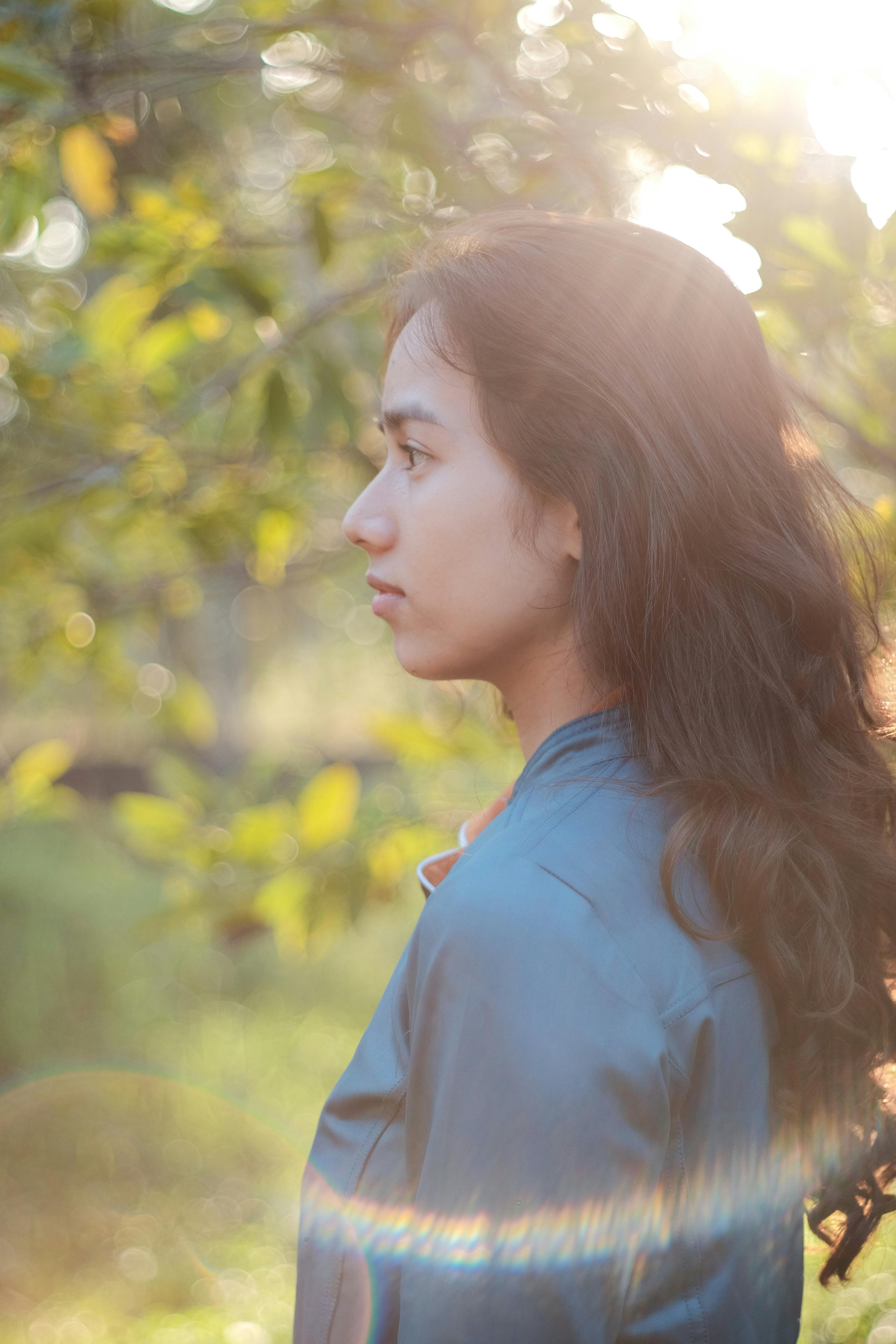Woman Standing in the Sunlight · Free Stock Photo