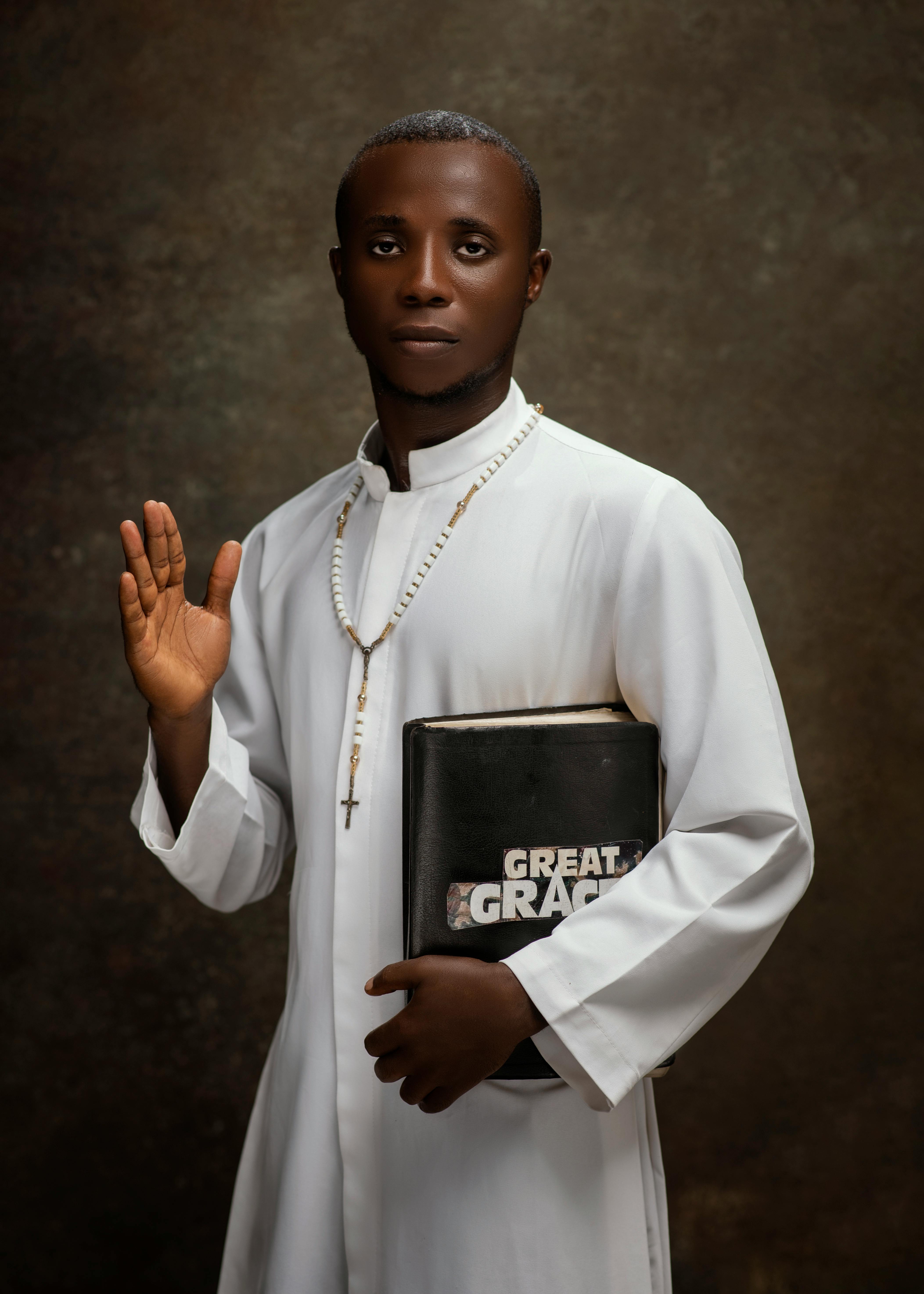 A Priest in a White Habit Wearing a Rosary and Holding a Book · Free ...
