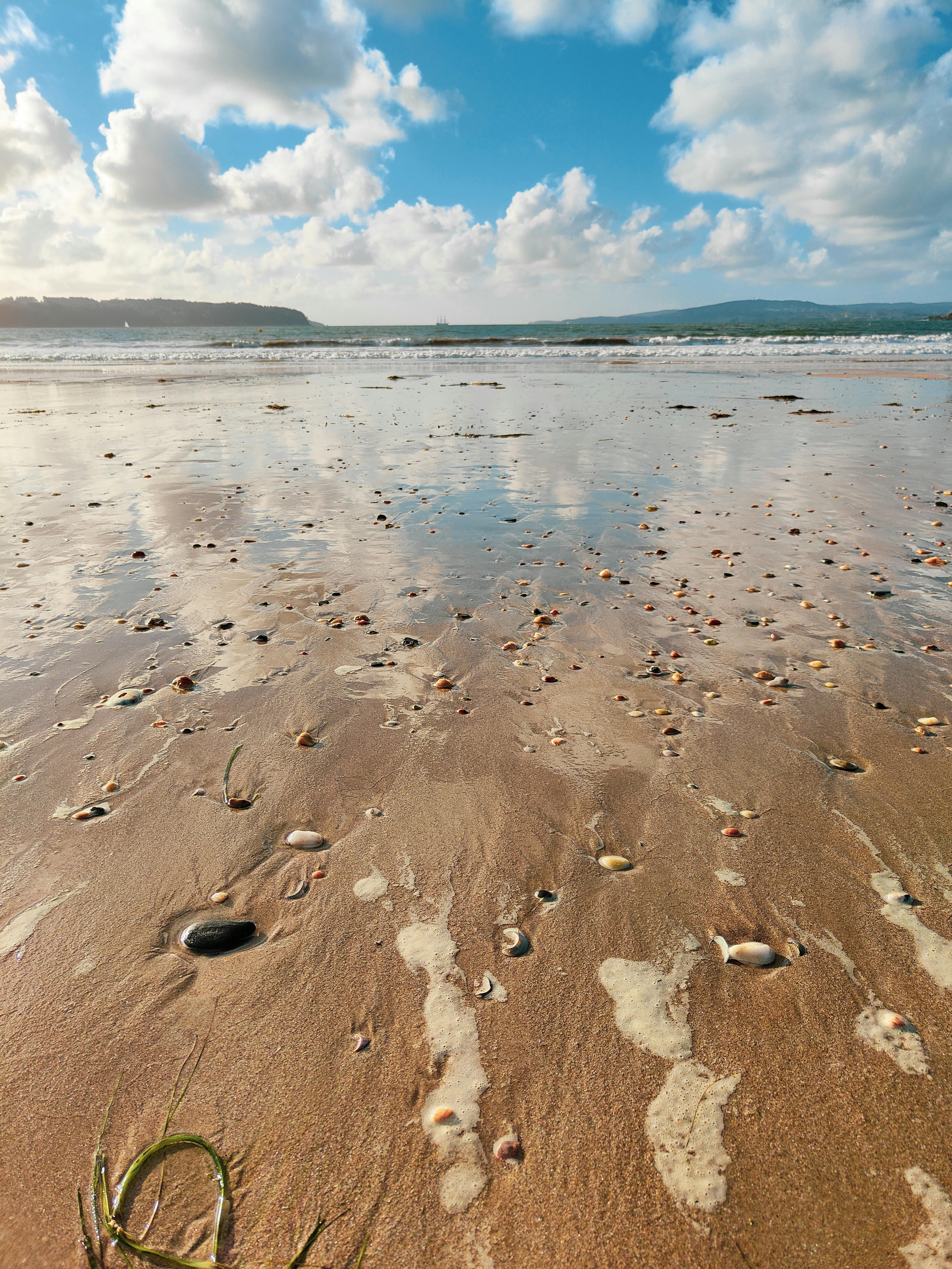 Wet Sand on the Beach and Hills in the Horizon · Free Stock Photo