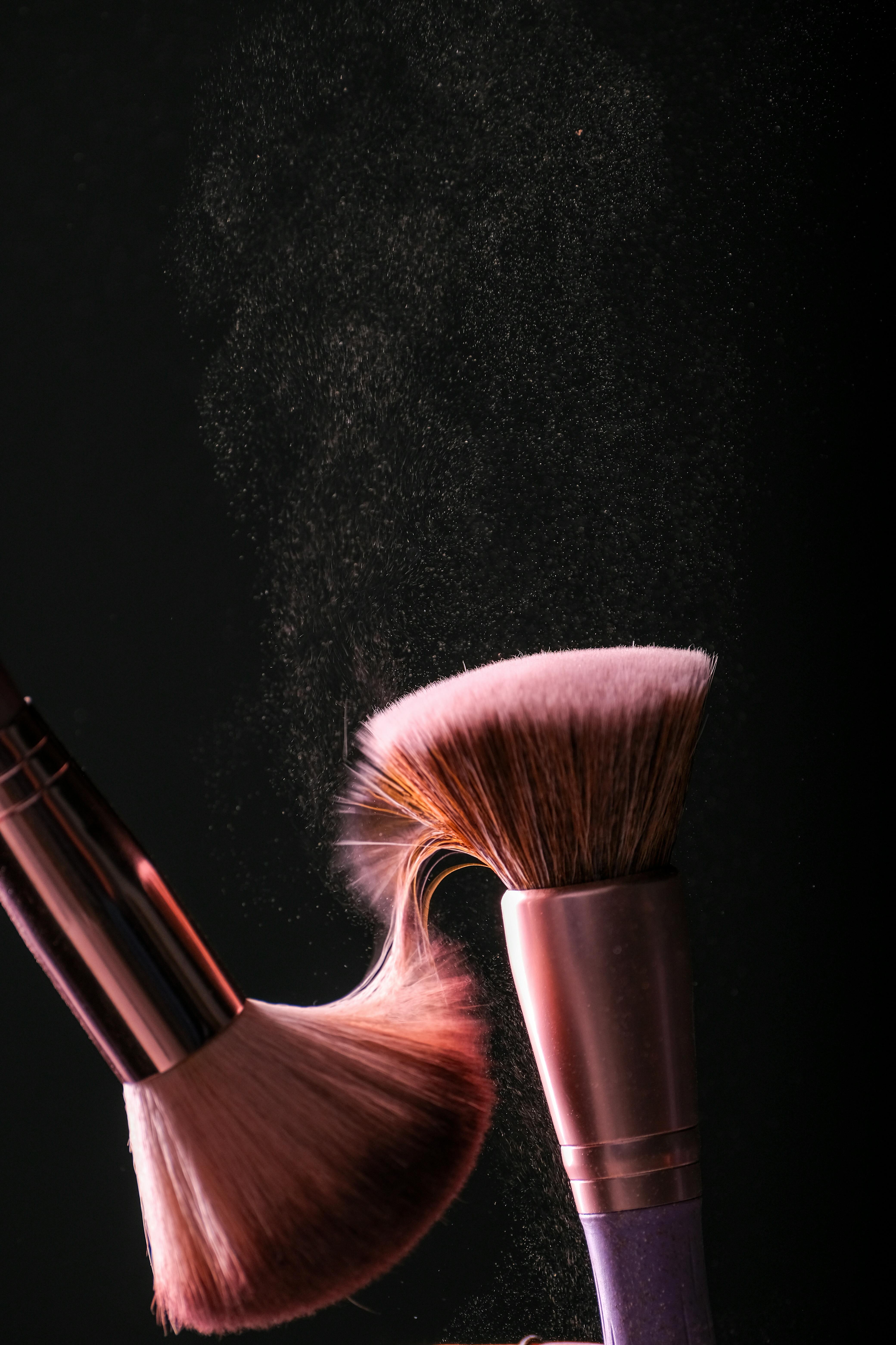 Cosmetics Makeup Brushes and Powder Dust Explosion · Free Stock Photo