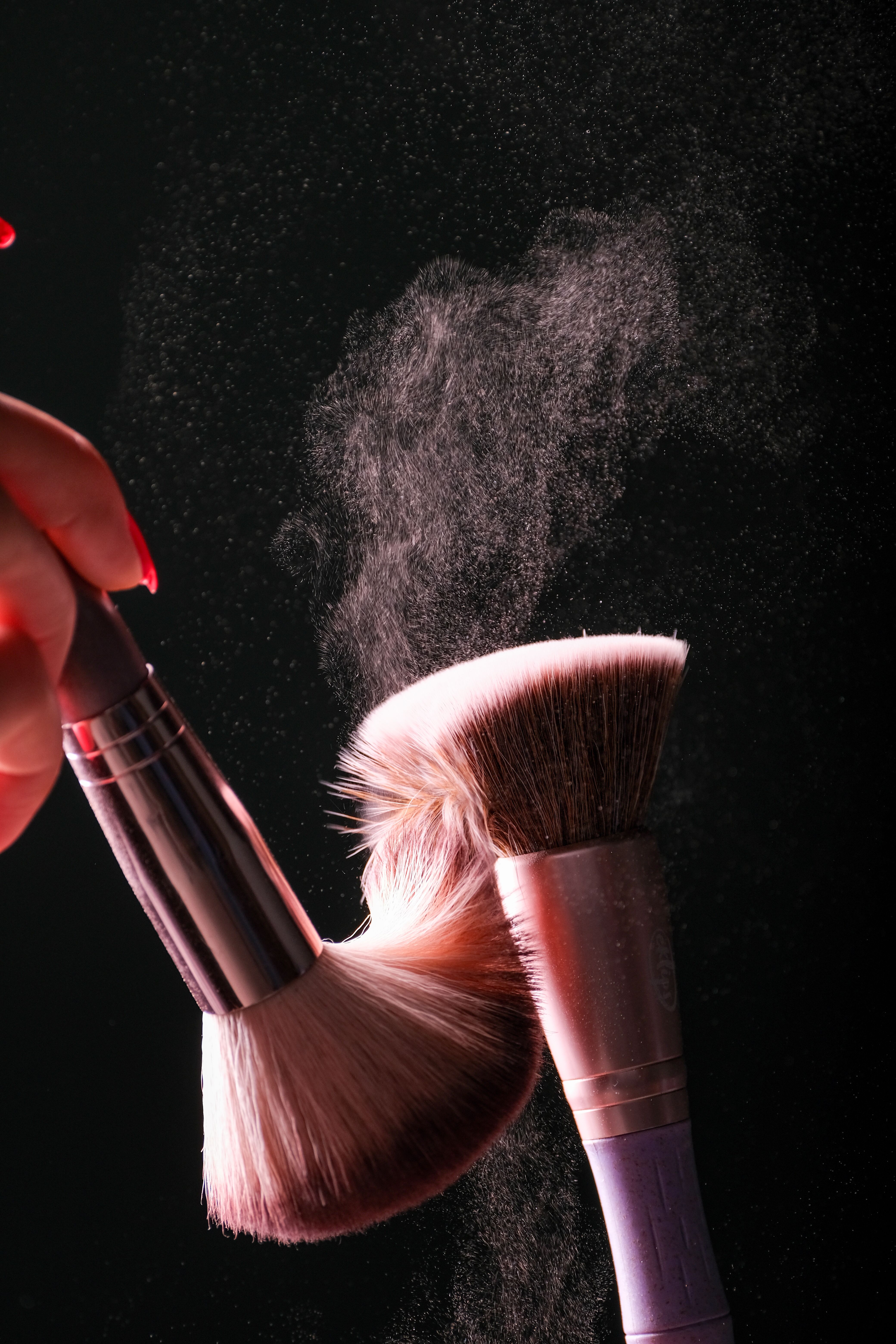 Cosmetics Makeup Brushes and Powder Dust Explosion · Free Stock Photo