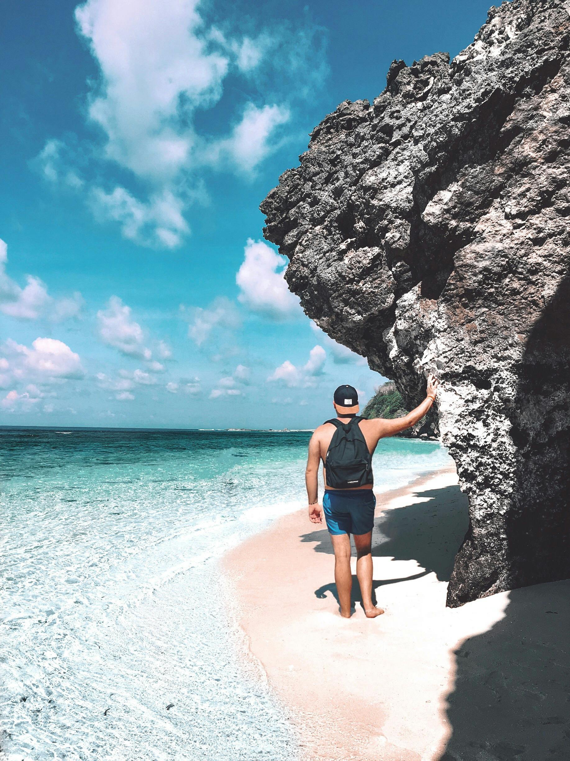 Man Wearing Black Backpack Standing Seashore · Free Stock Photo