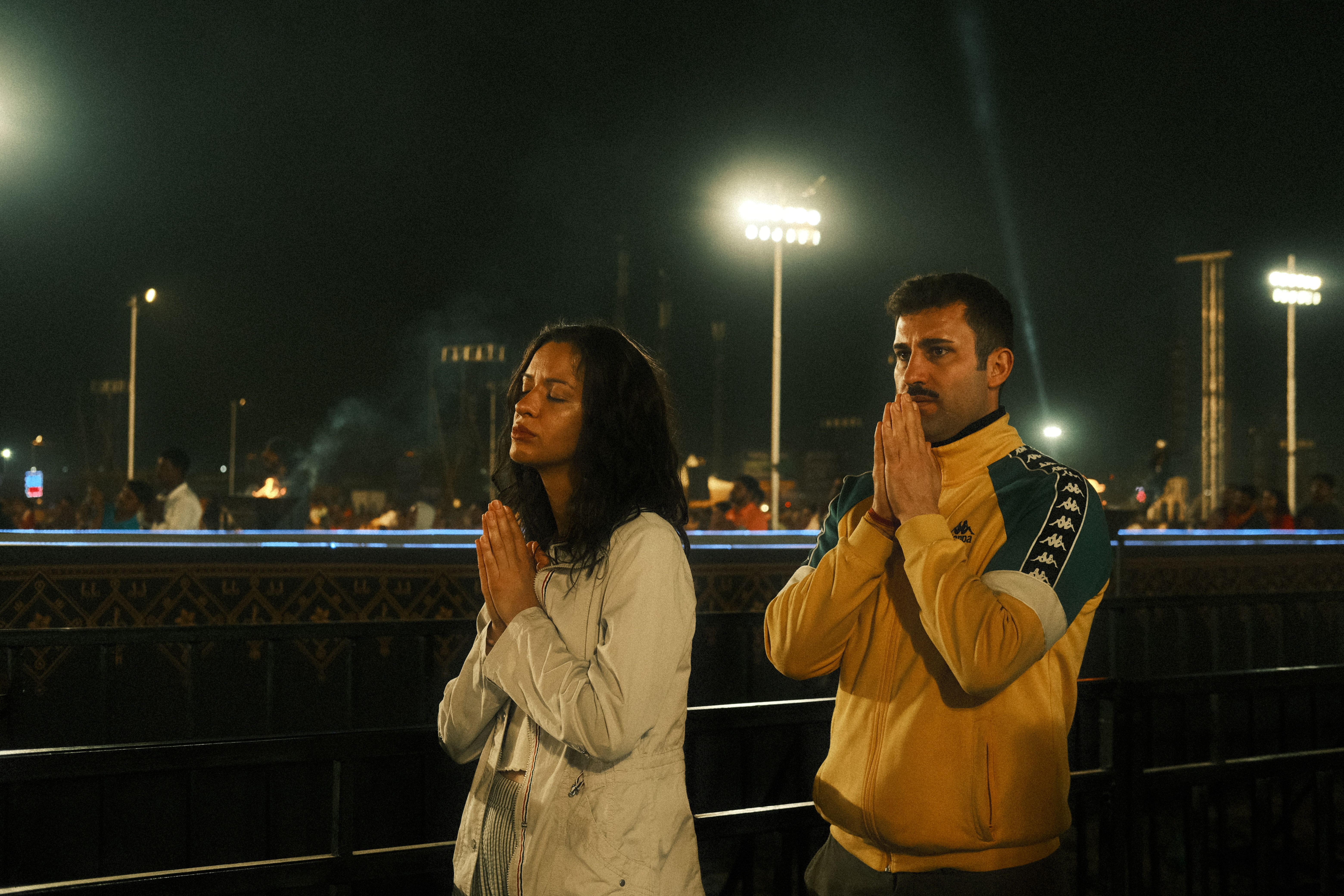 A Man and Woman Praying Outside at Night · Free Stock Photo
