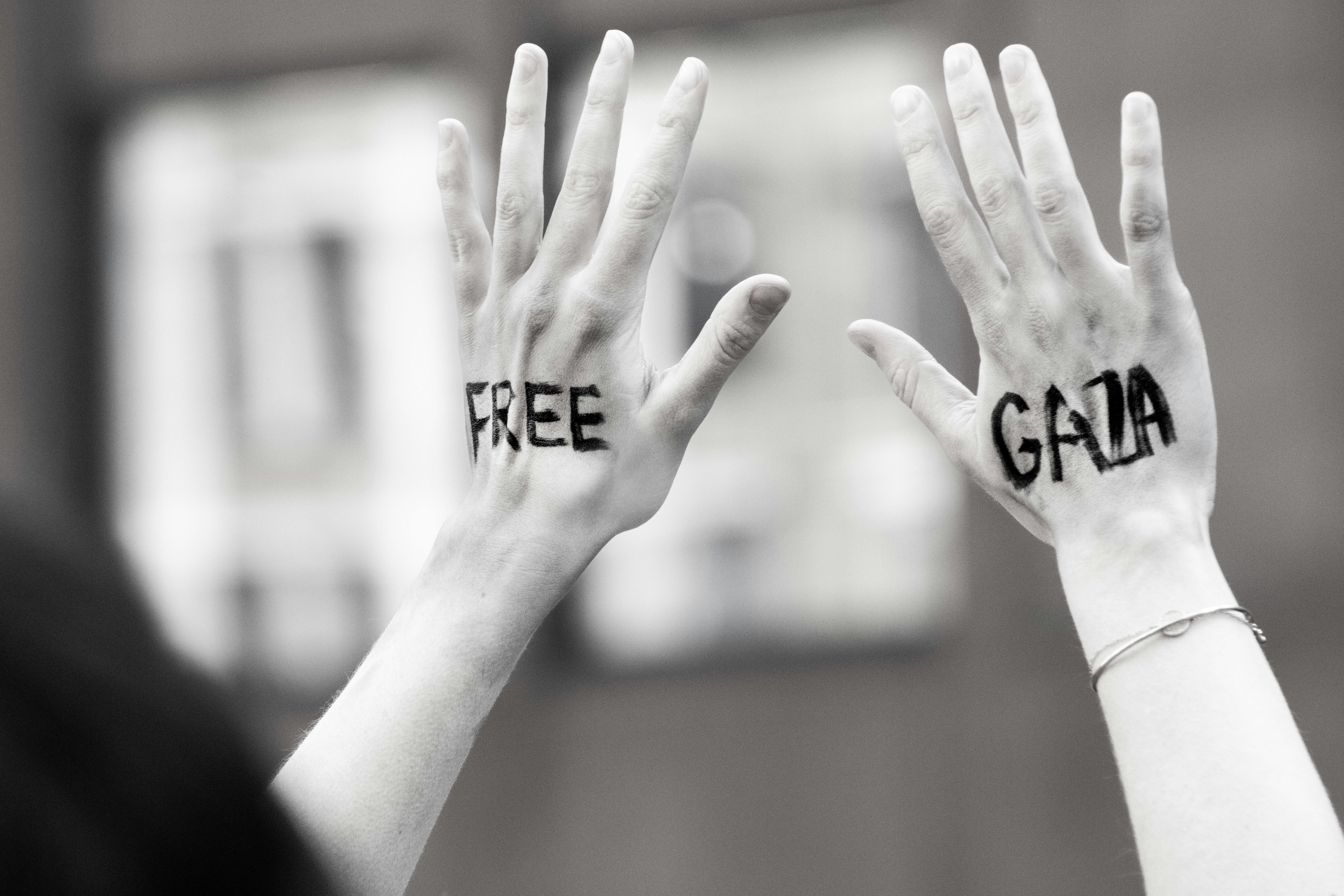 Two hands with the words free and gaza written on them · Free Stock Photo
