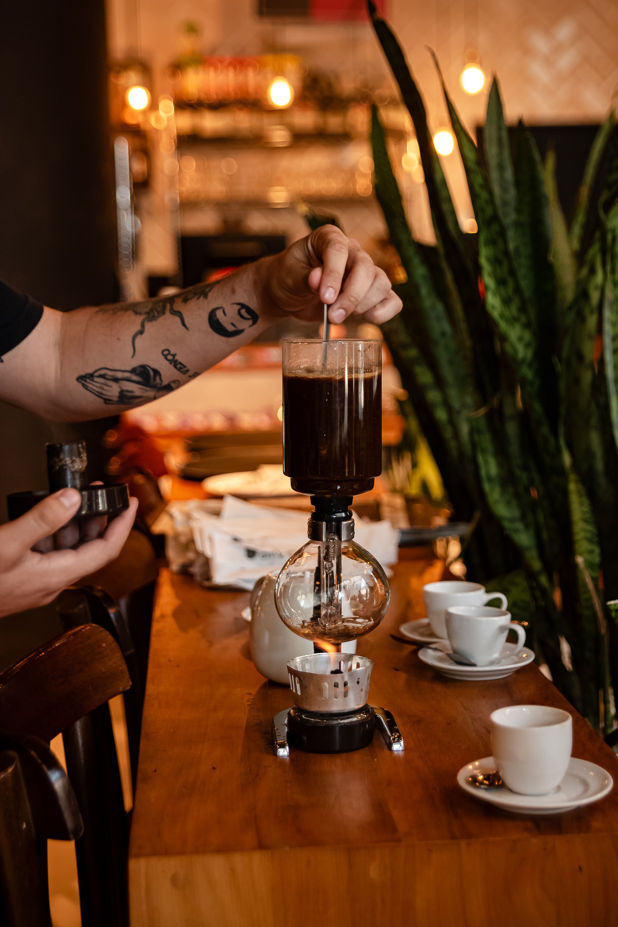 Arm of Man Pouring Coffee at Cafe · Free Stock Photo