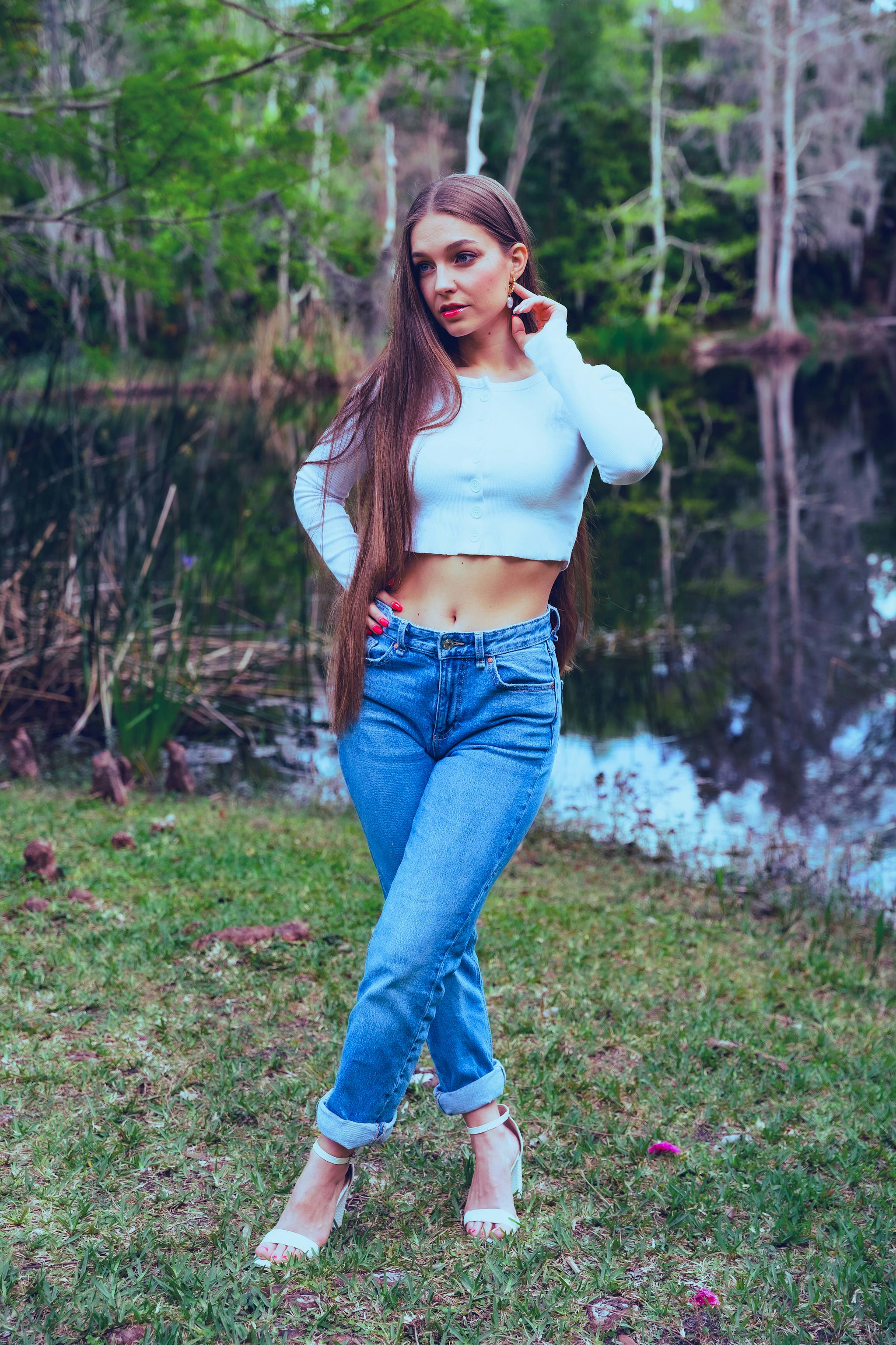 Pretty Brunette Posing on a Lakeshore · Free Stock Photo