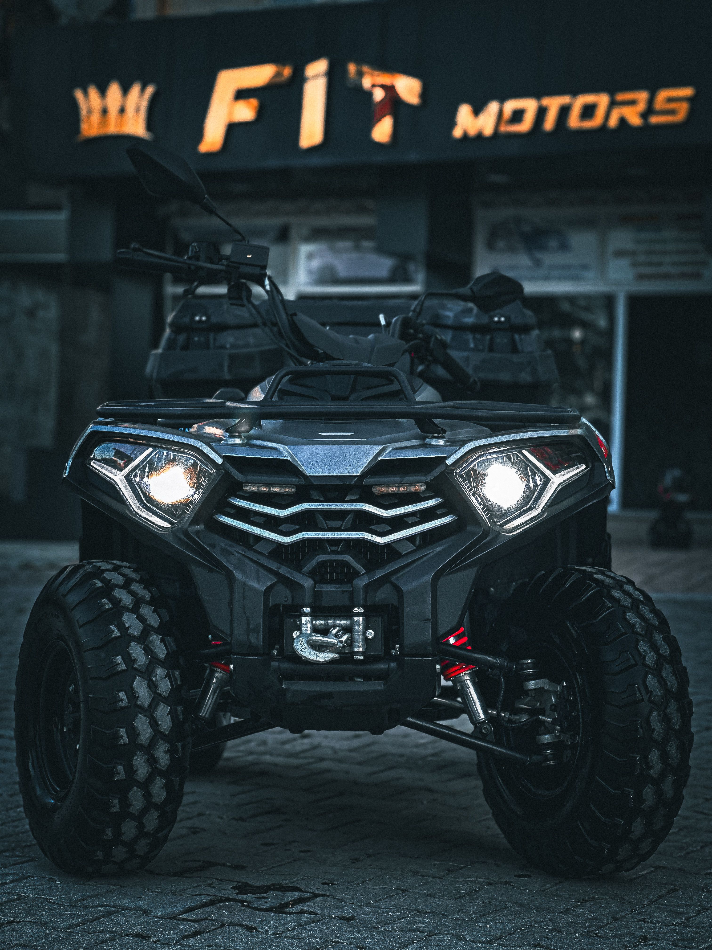 A Modern Quad Bike Parked in Front of a Building · Free Stock Photo