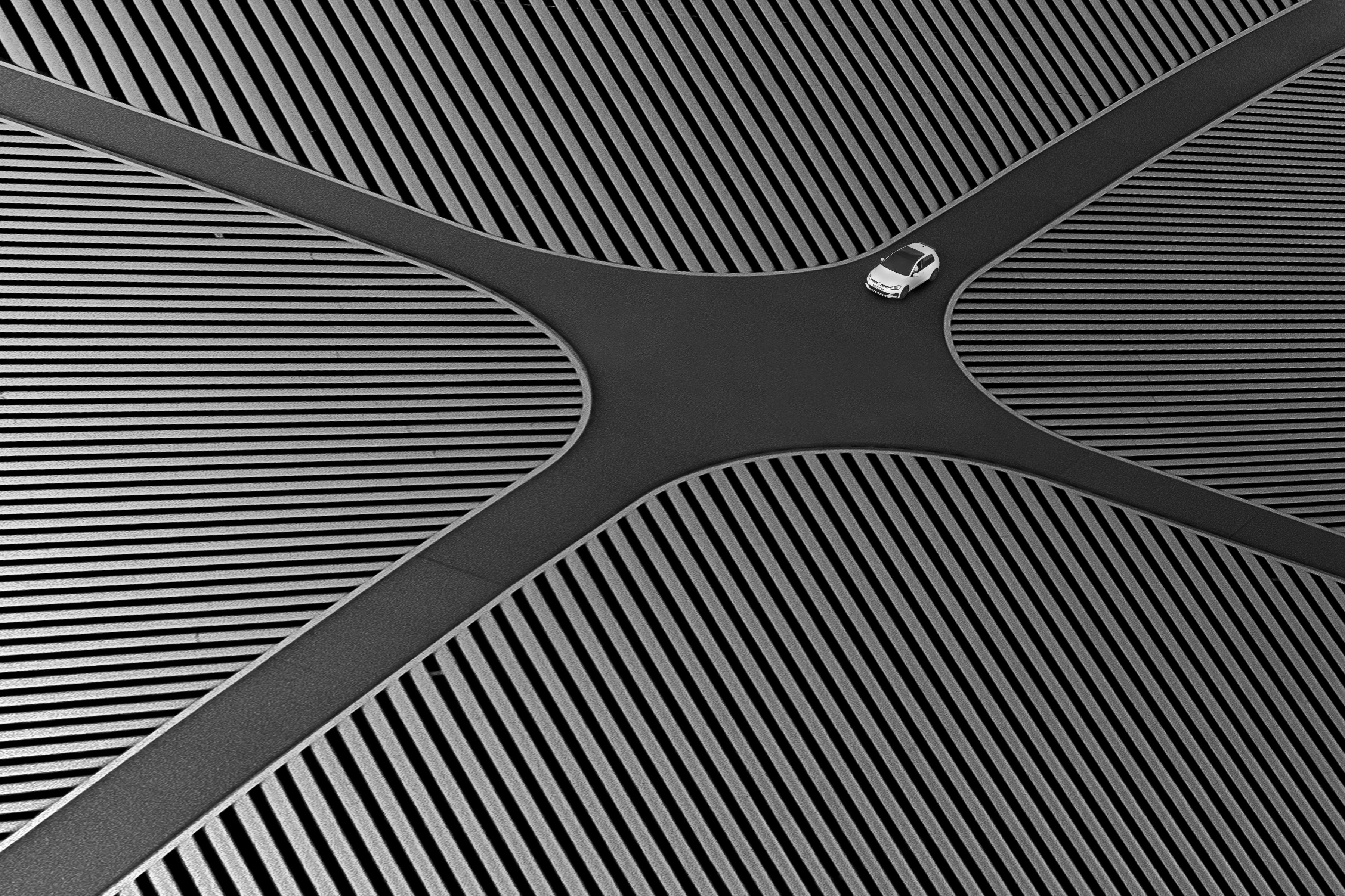 White Car on Intersection Among Stripes · Free Stock Photo