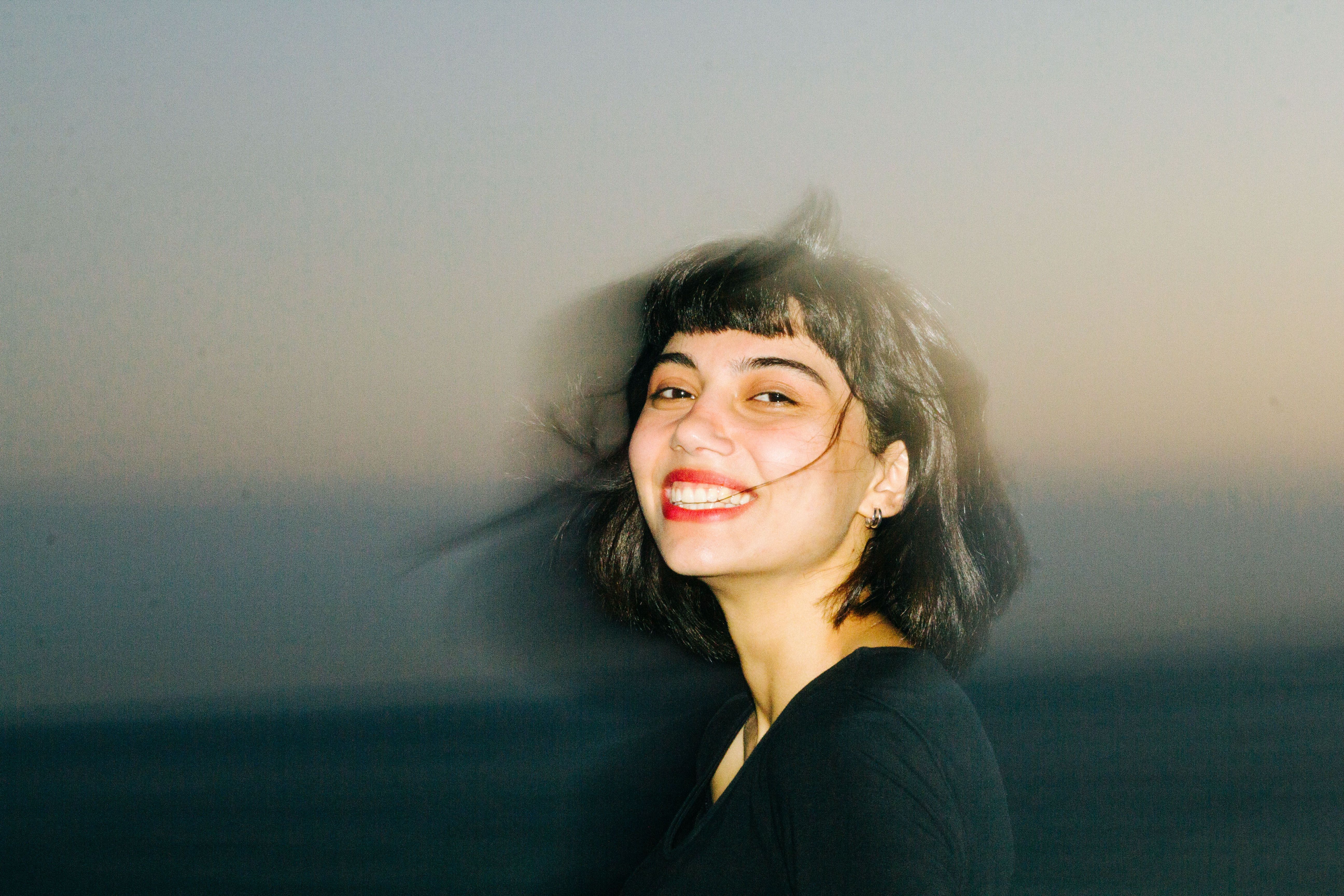 Blurry Photo of a Young Woman Standing Outside at Sunset · Free Stock Photo