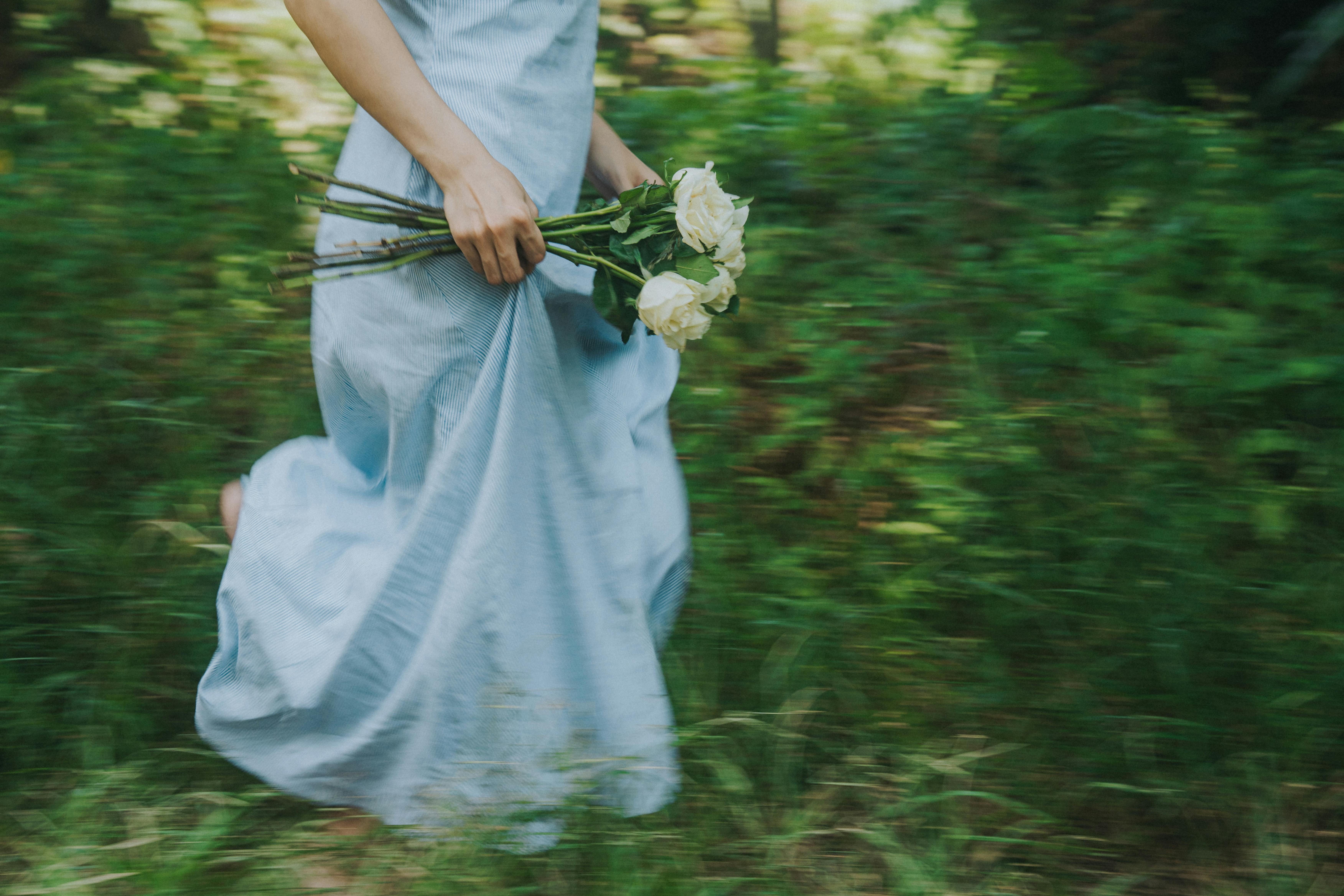 A Woman in a Long, Blue Dress Running on the Grass · Free Stock Photo