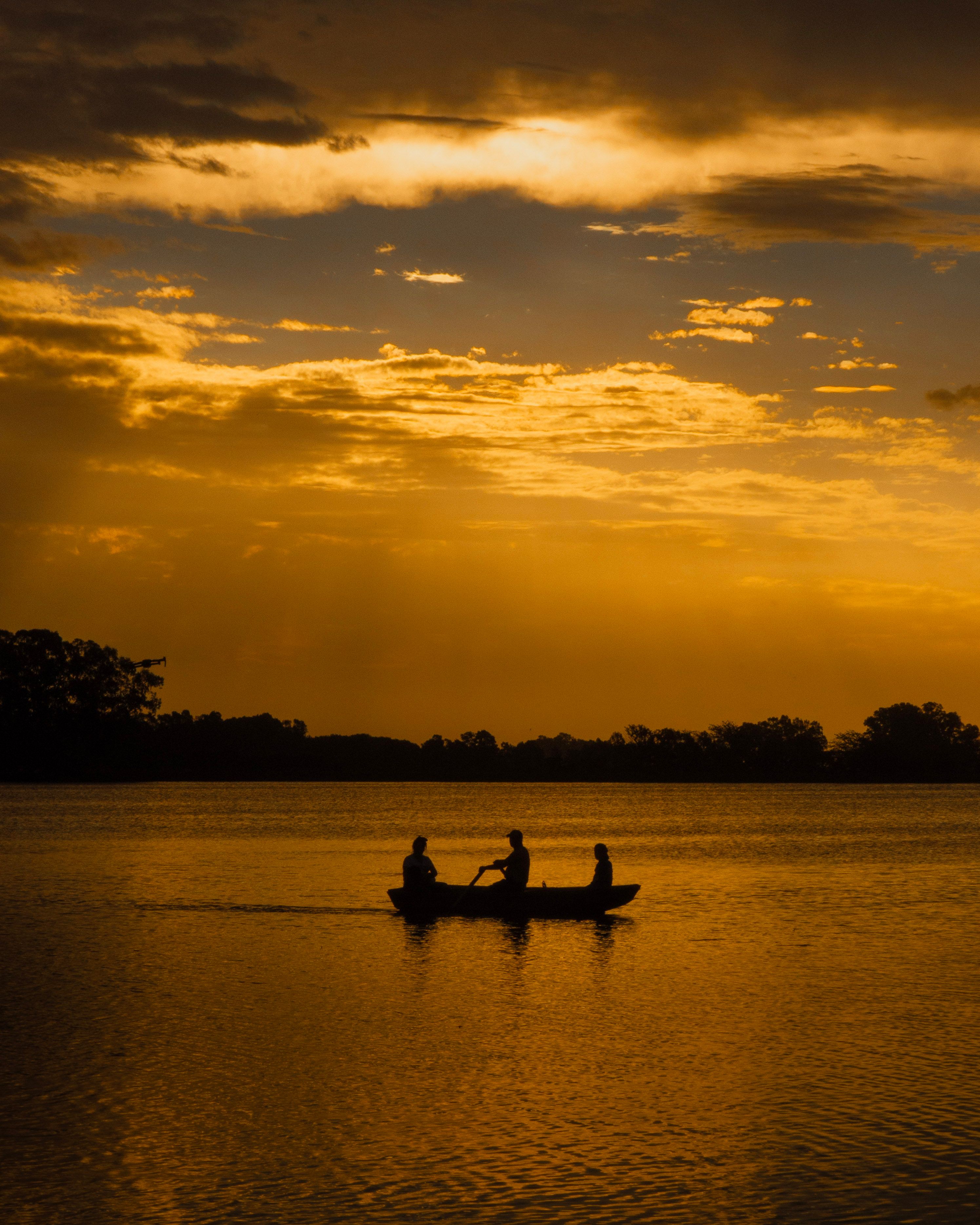 People on Boat on Lake at Sunset · Free Stock Photo
