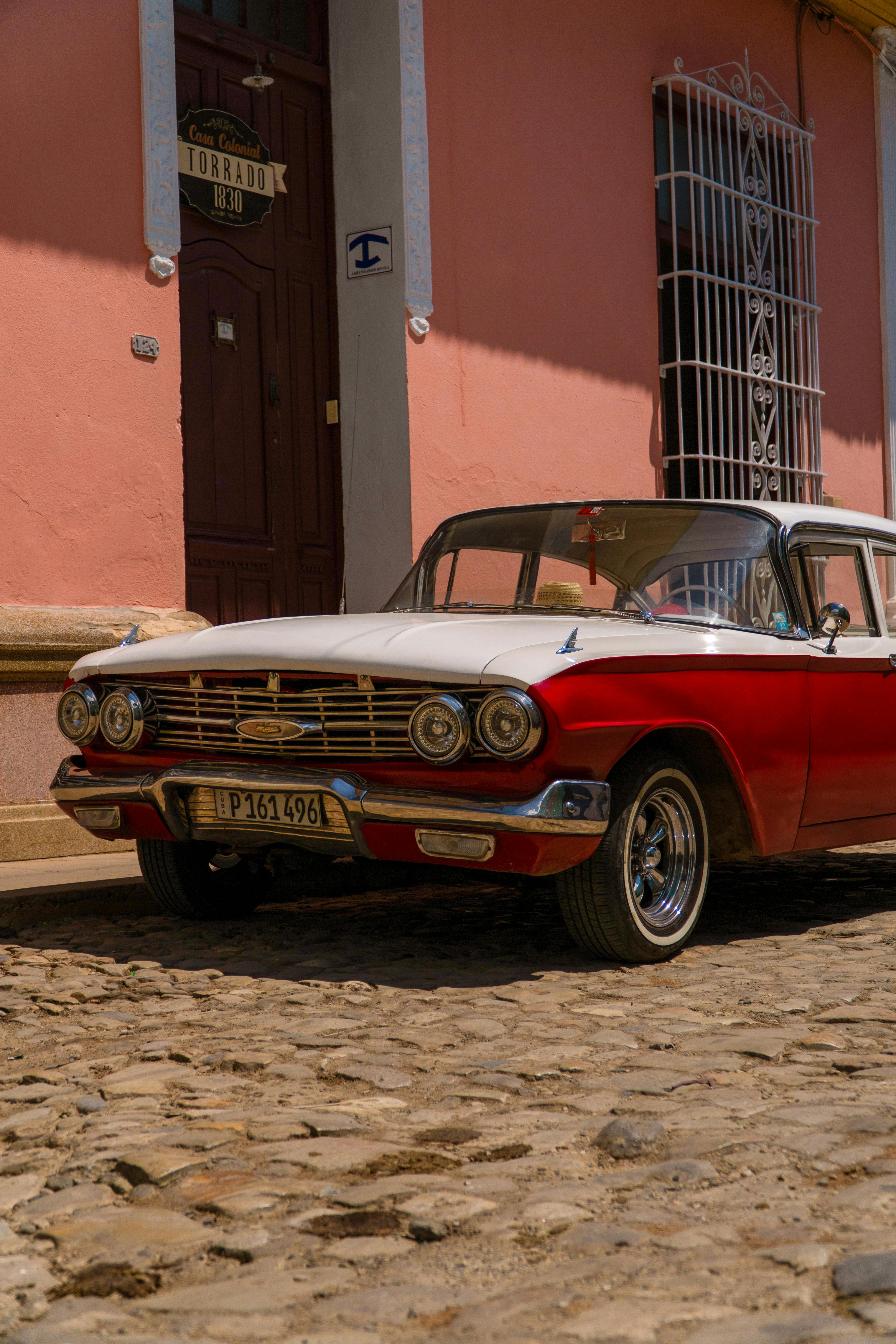 A Vintage Car in a Town · Free Stock Photo
