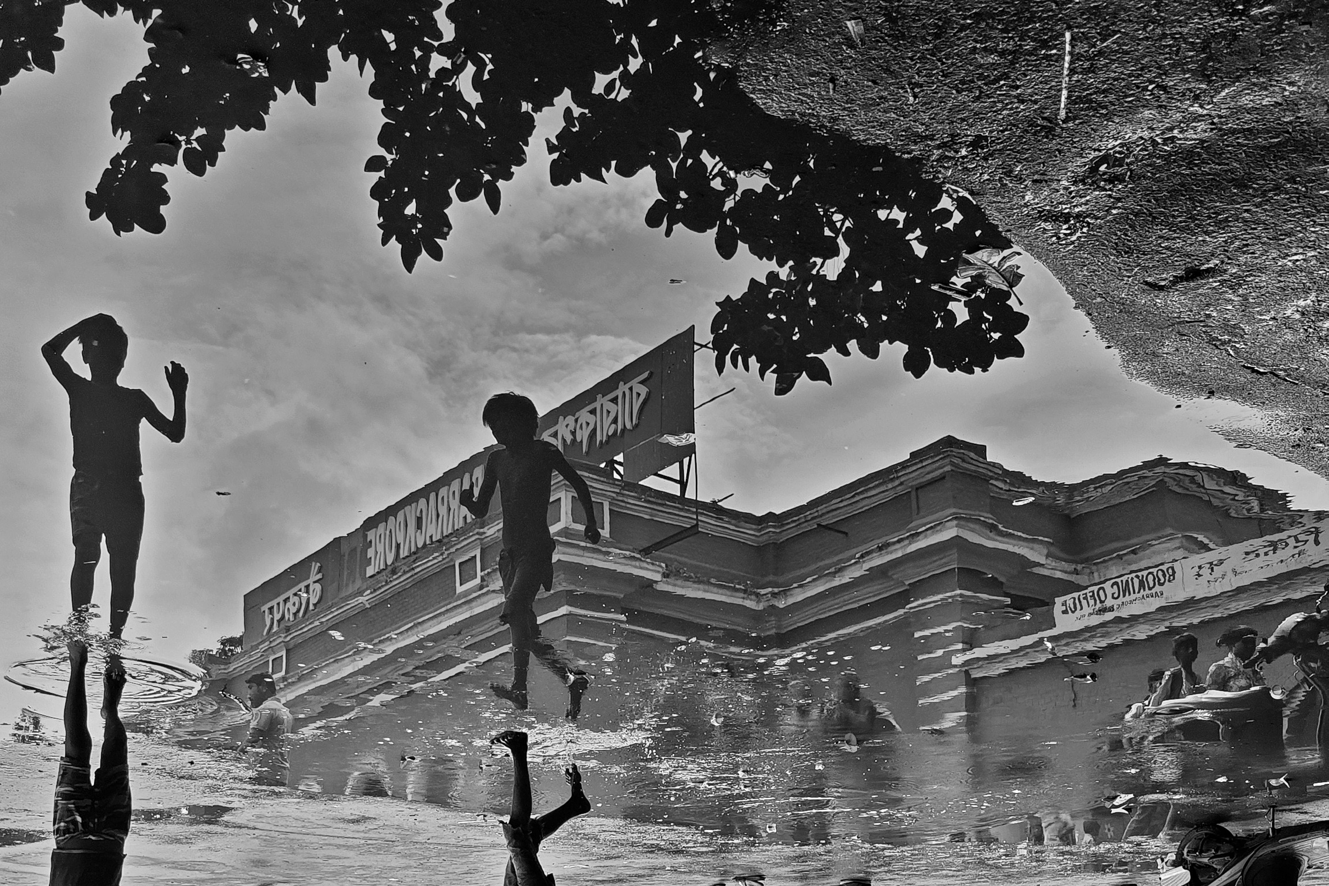 Reflection of Children in Water Puddle · Free Stock Photo
