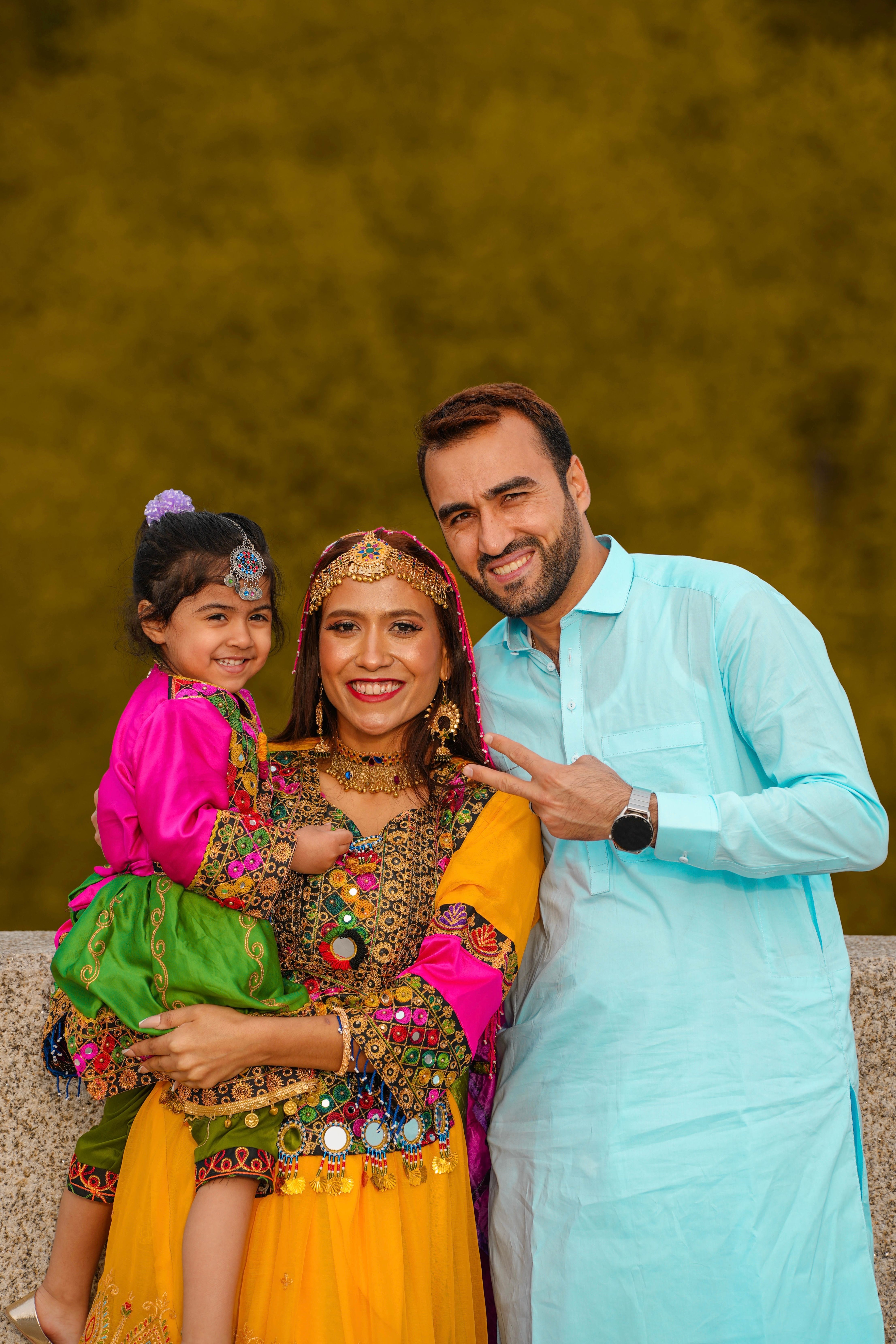 Father and Mother with Daughter in Traditional Clothing · Free Stock Photo