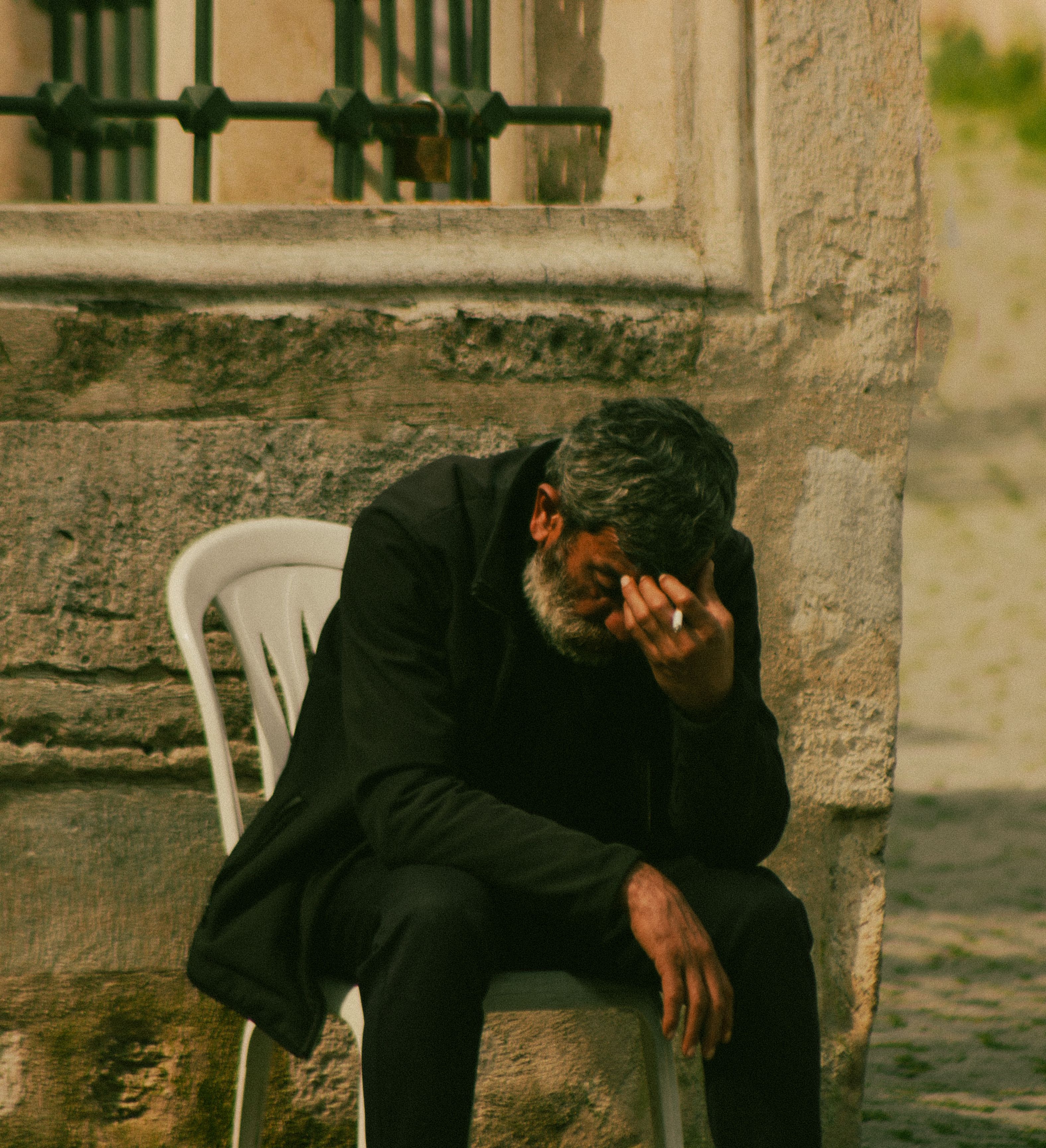 Man Sitting and Smoking Cigarette · Free Stock Photo