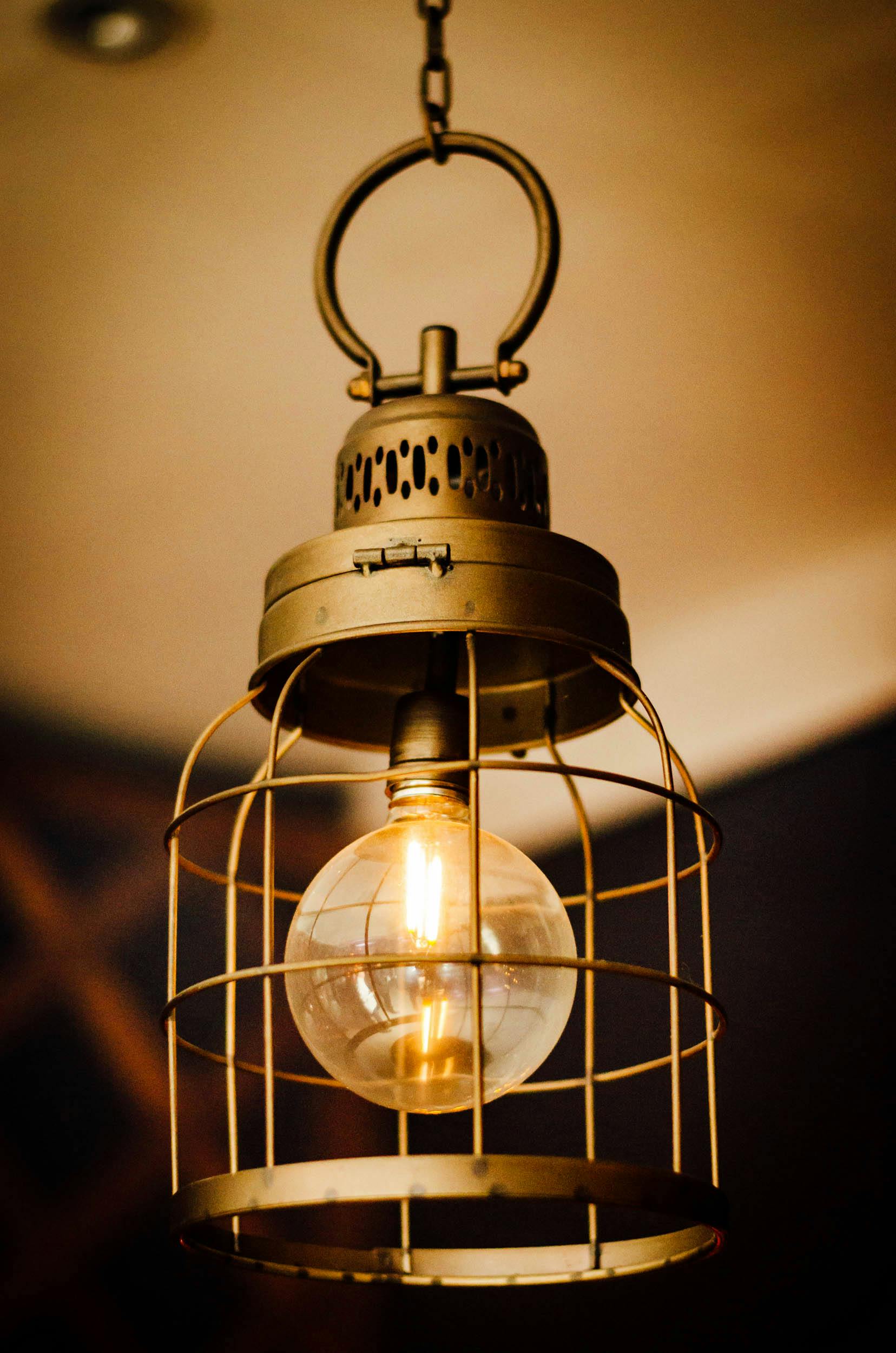 Four Hanging Light Bulbs Beside Chair · Free Stock Photo