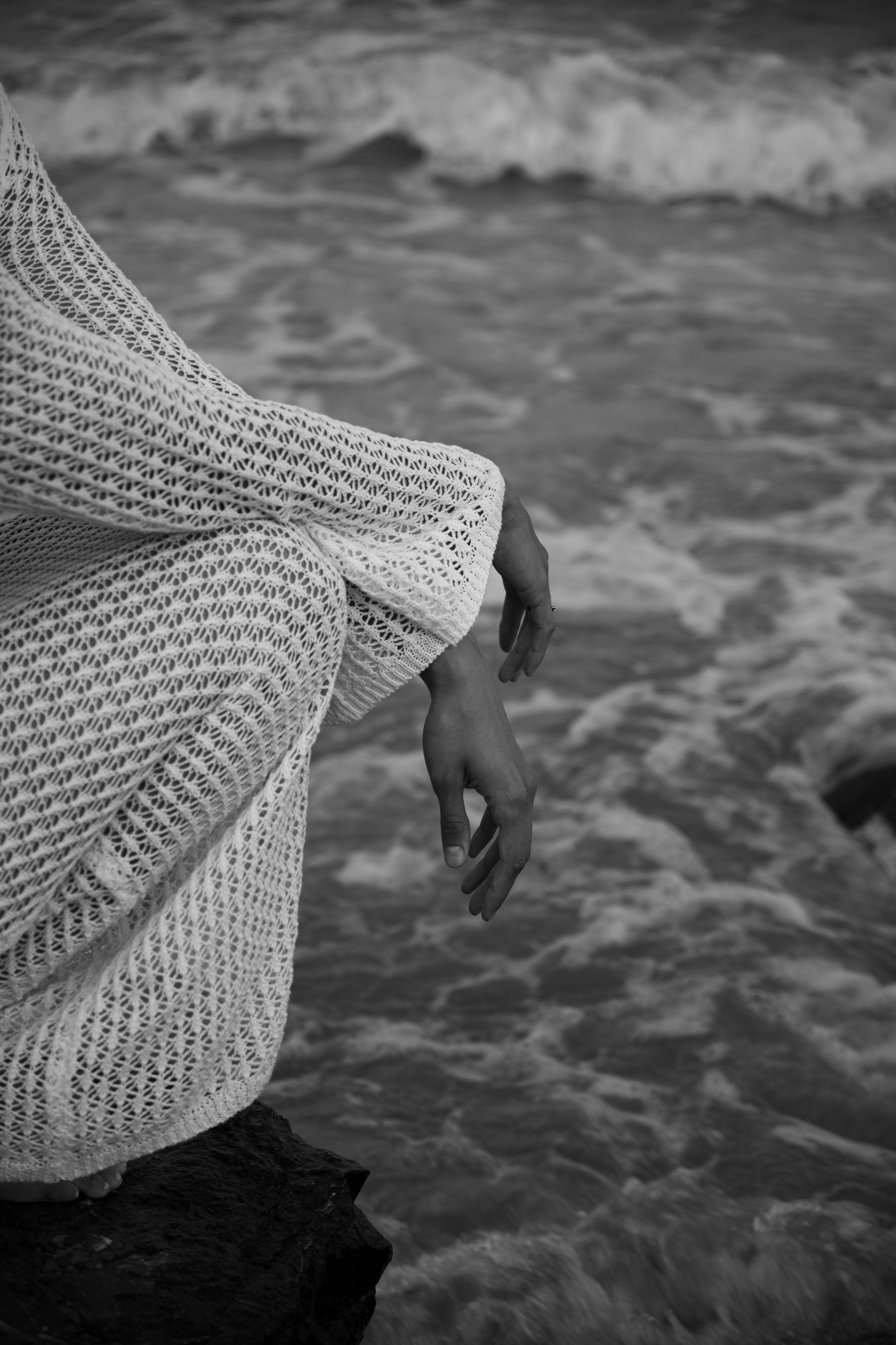 Closeup of Woman Hands Hanging over Rocky Shore · Free Stock Photo