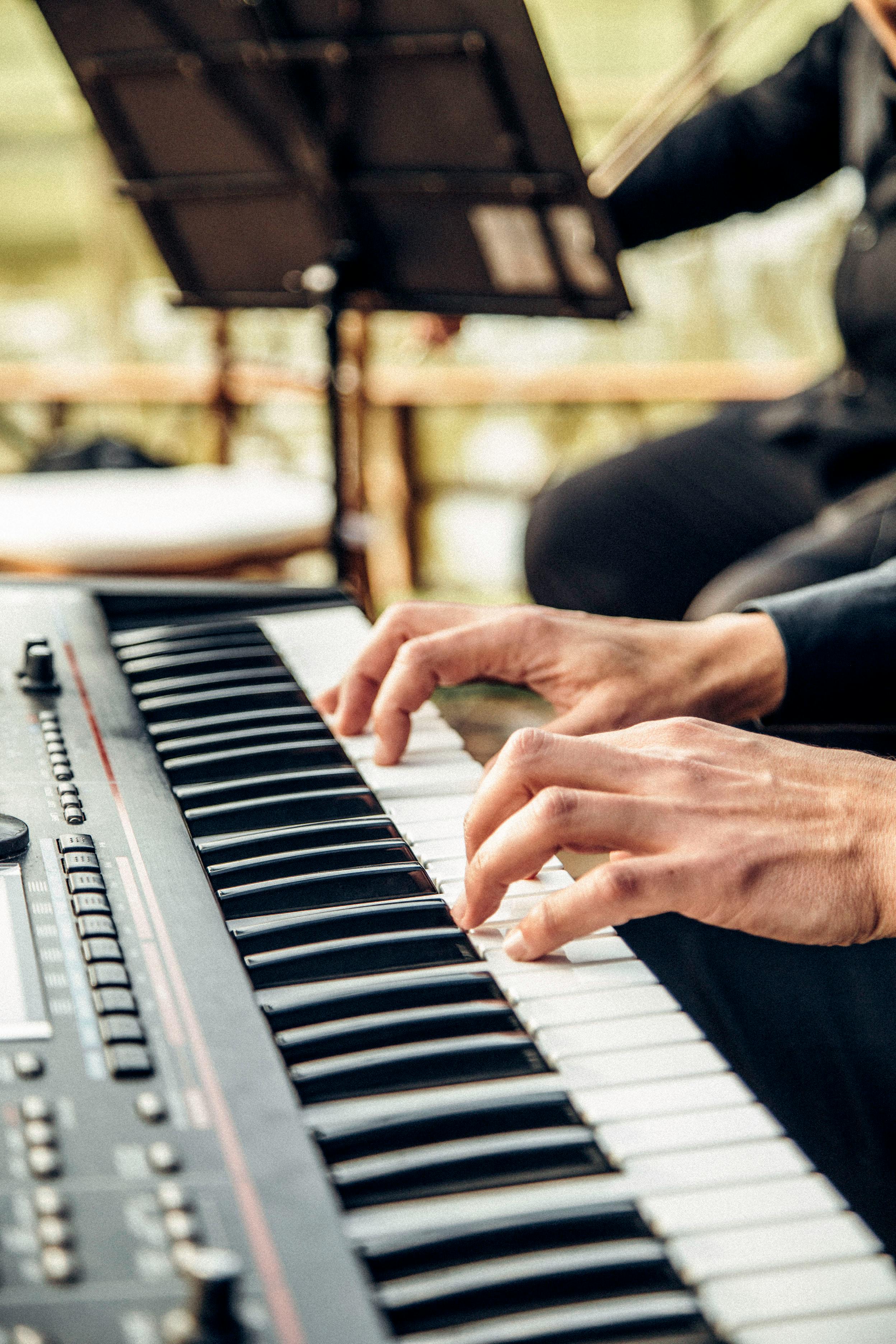 A person playing the piano with their hands · Free Stock Photo