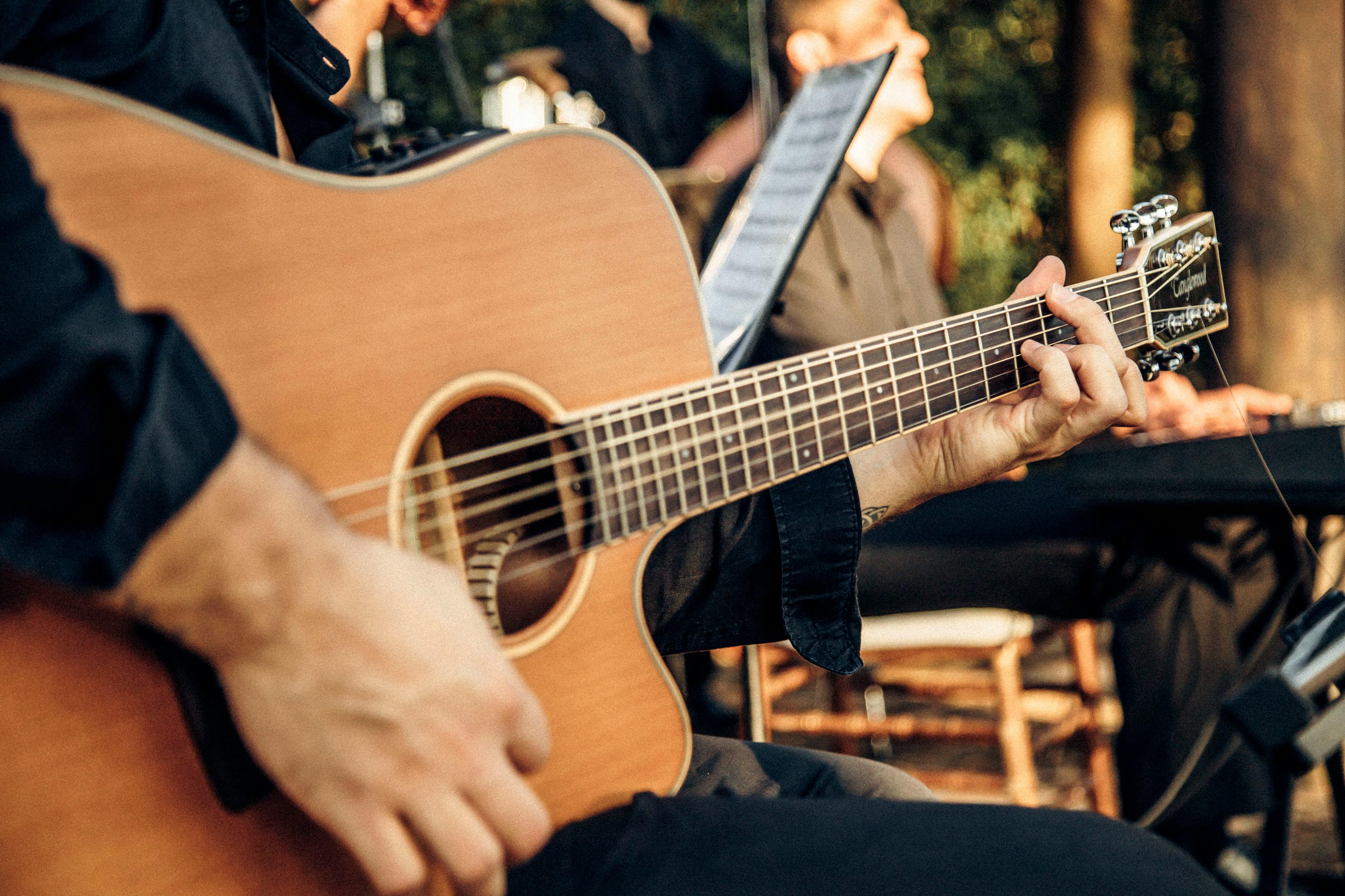 Playing acoustic guitar · Free Stock Photo