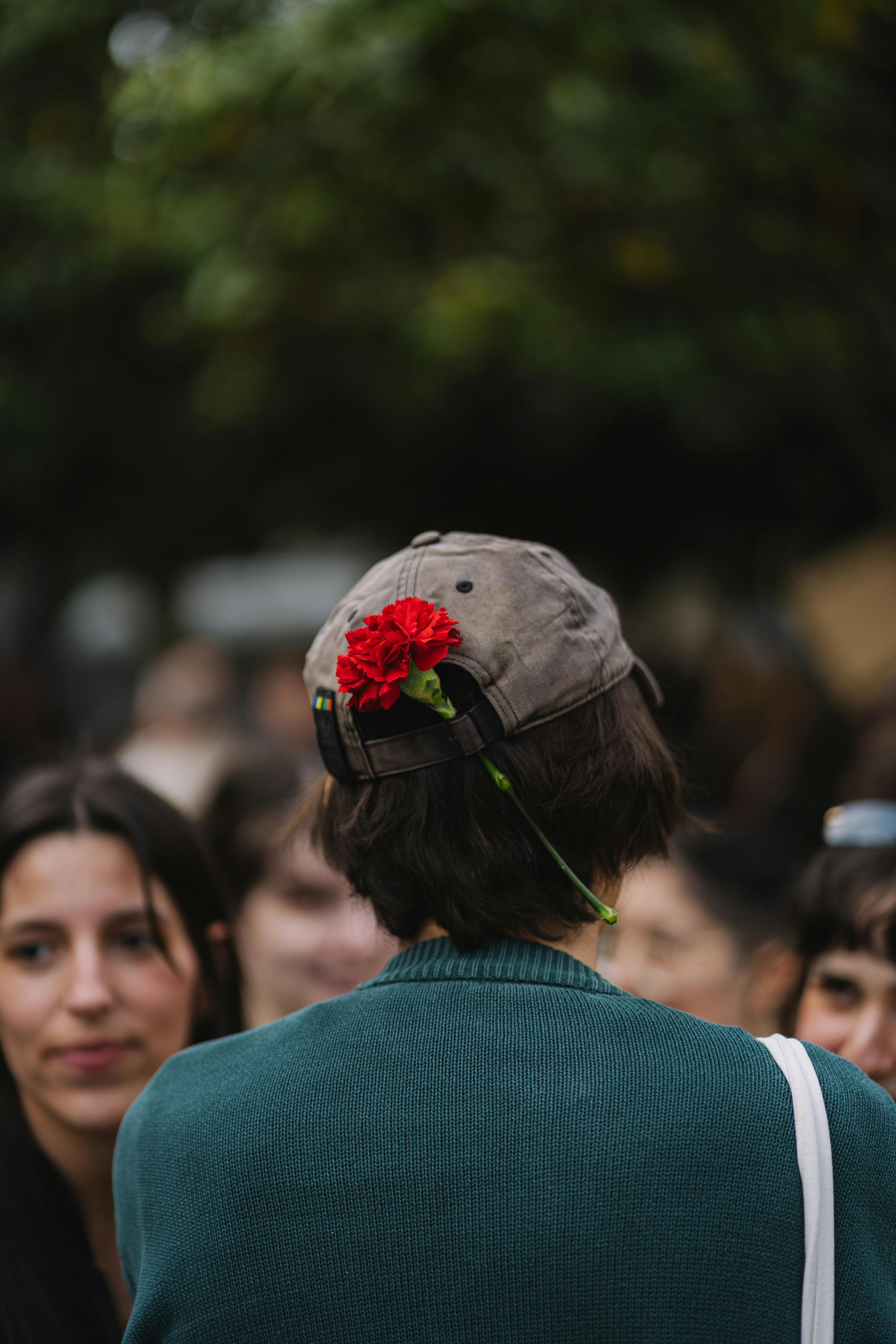 Woman Wearing Cap with Carnation · Free Stock Photo