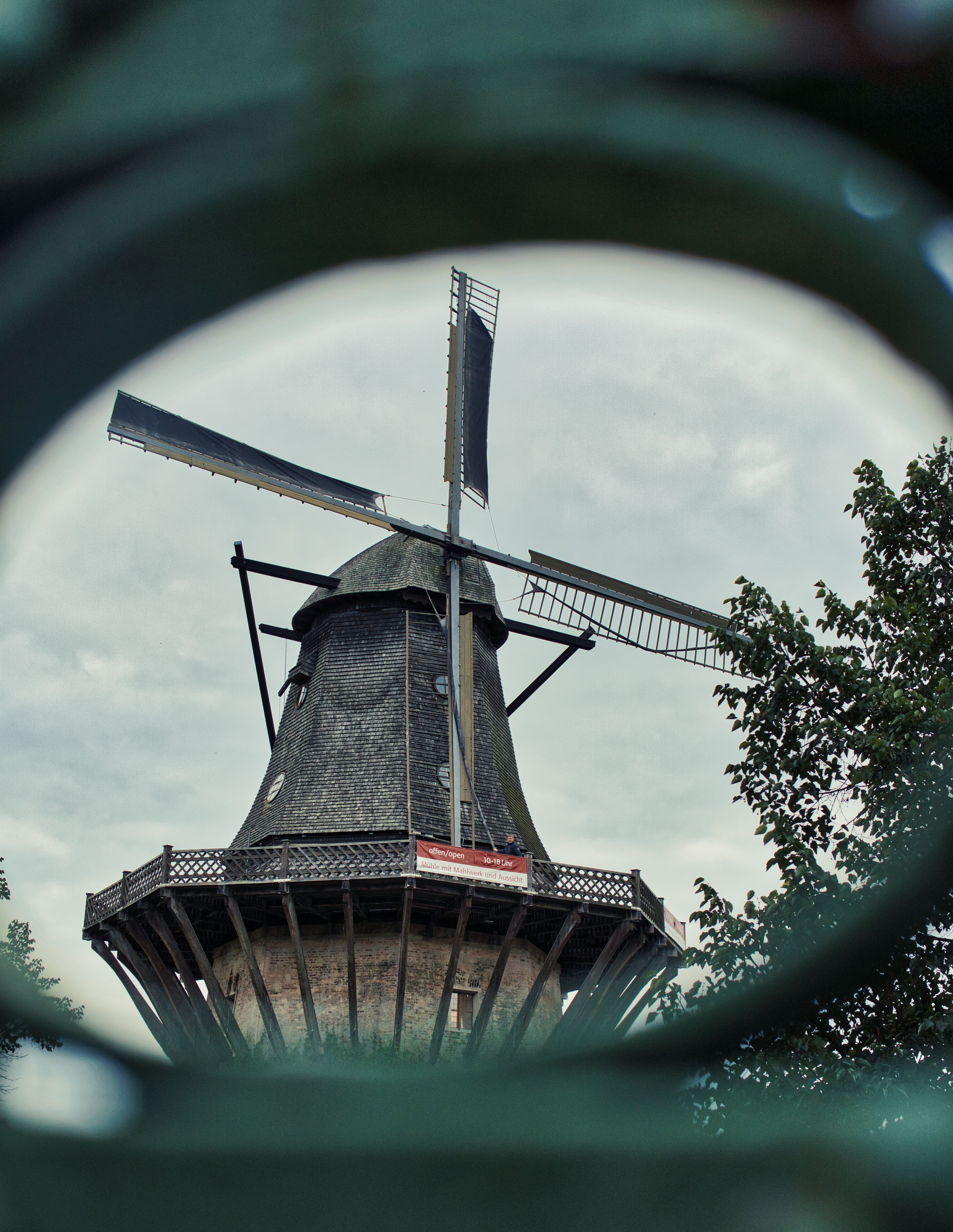 A Windmill Seen Through a Fence · Free Stock Photo