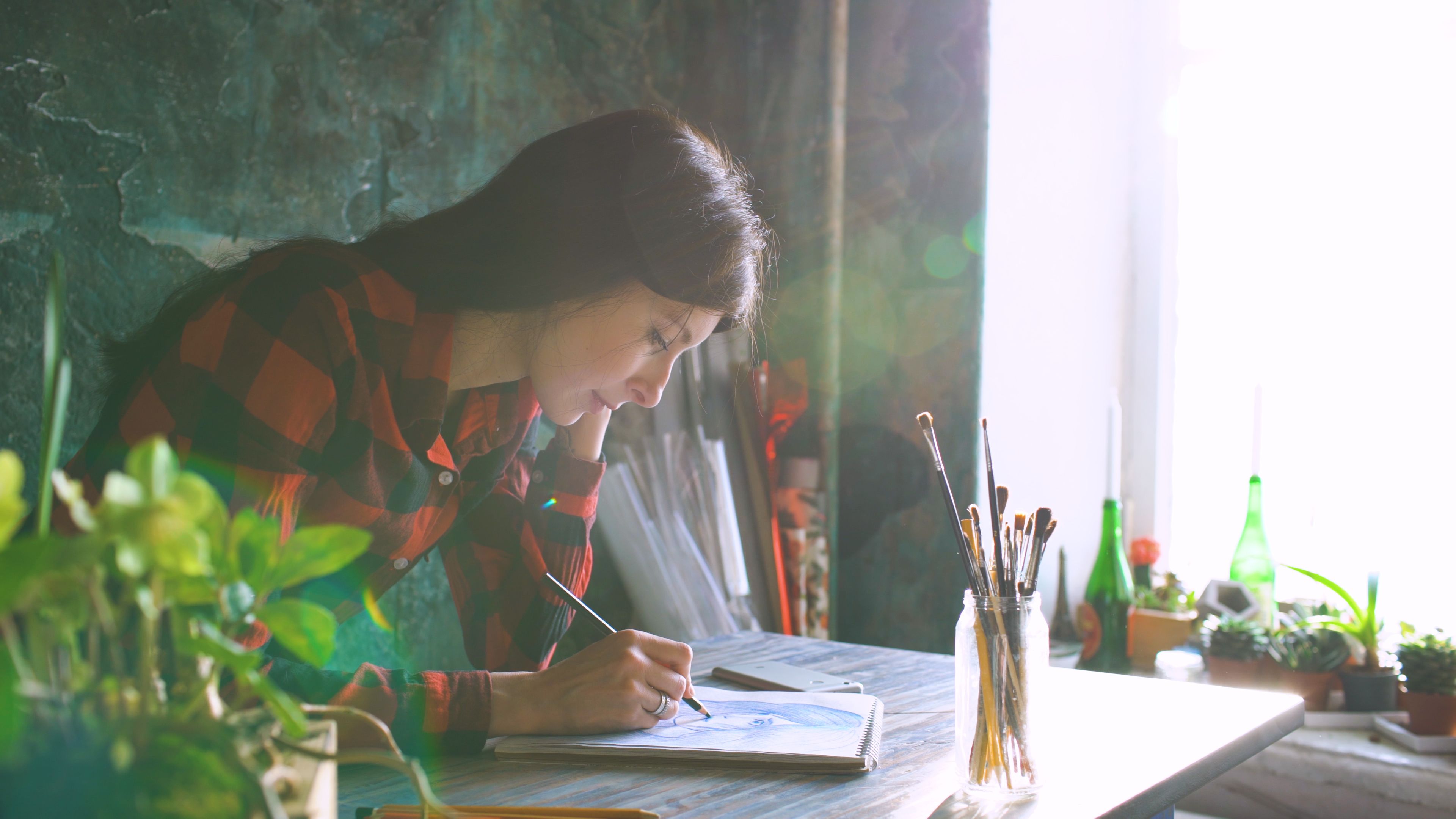 Woman Sketching at Table · Free Stock Photo