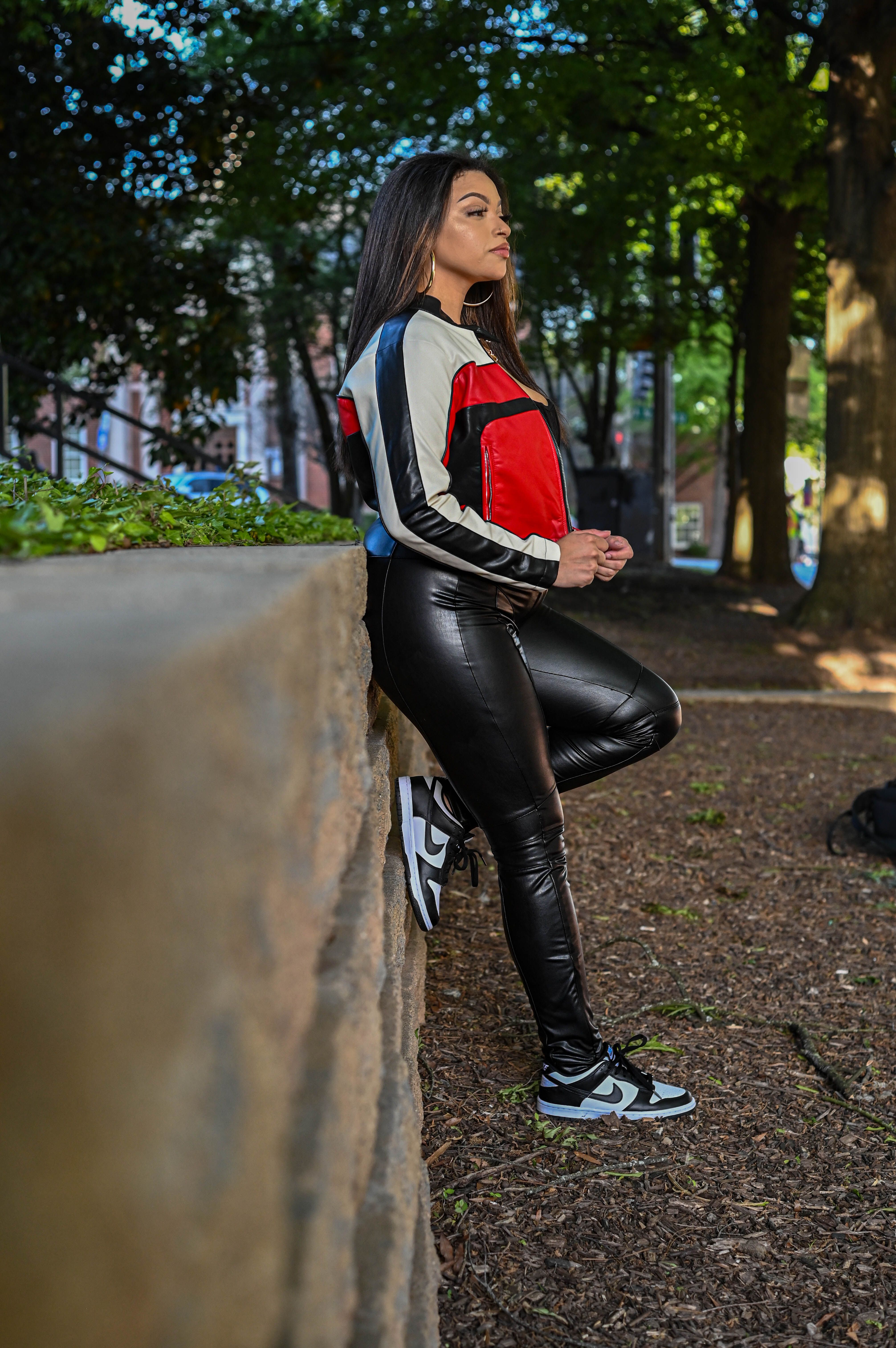 Female Model Leaning on a Wall in a Park · Free Stock Photo