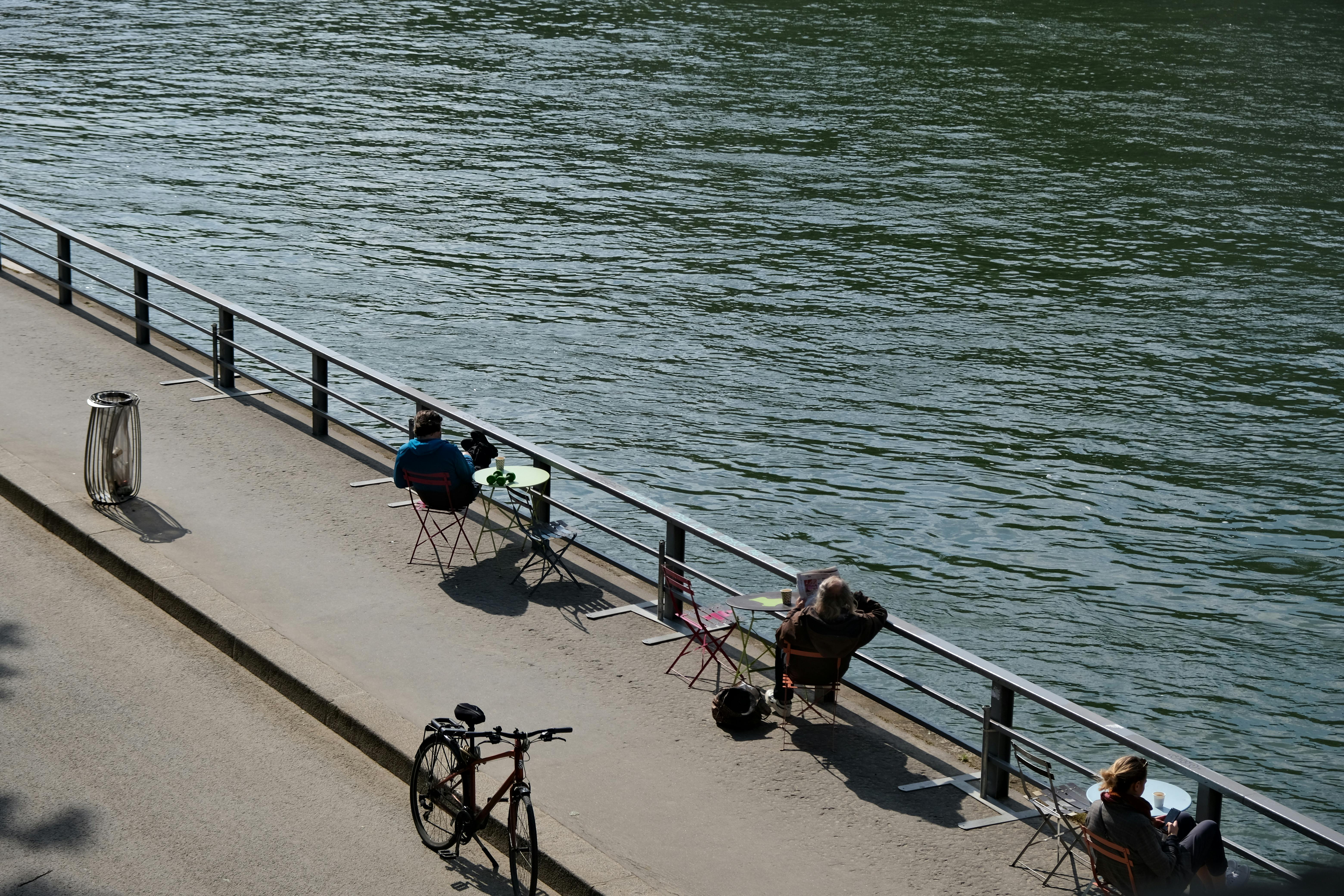 People Sitting on a Waterfront · Free Stock Photo