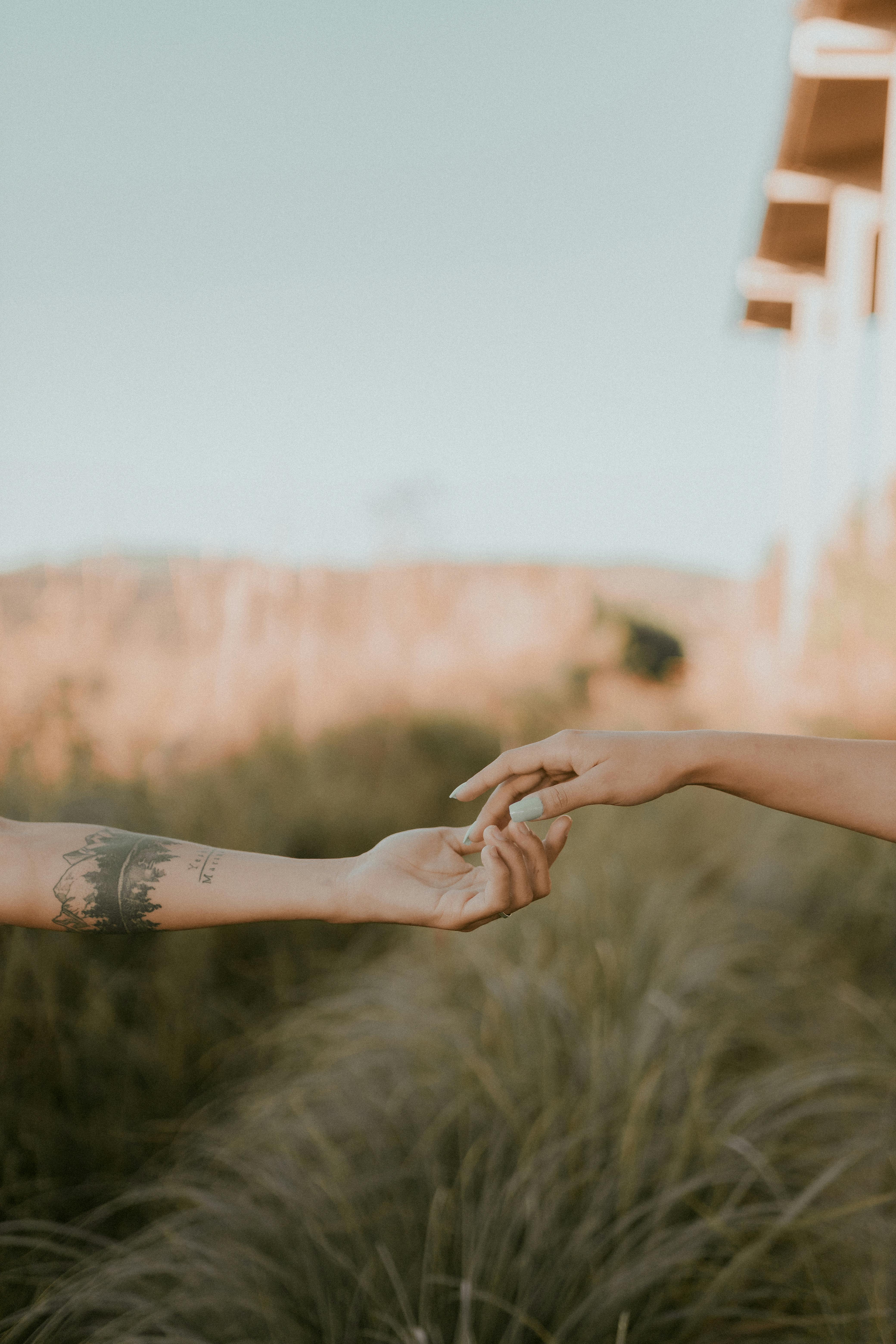 Close-up of Hands of a Man and Woman Barely Touching · Free Stock Photo