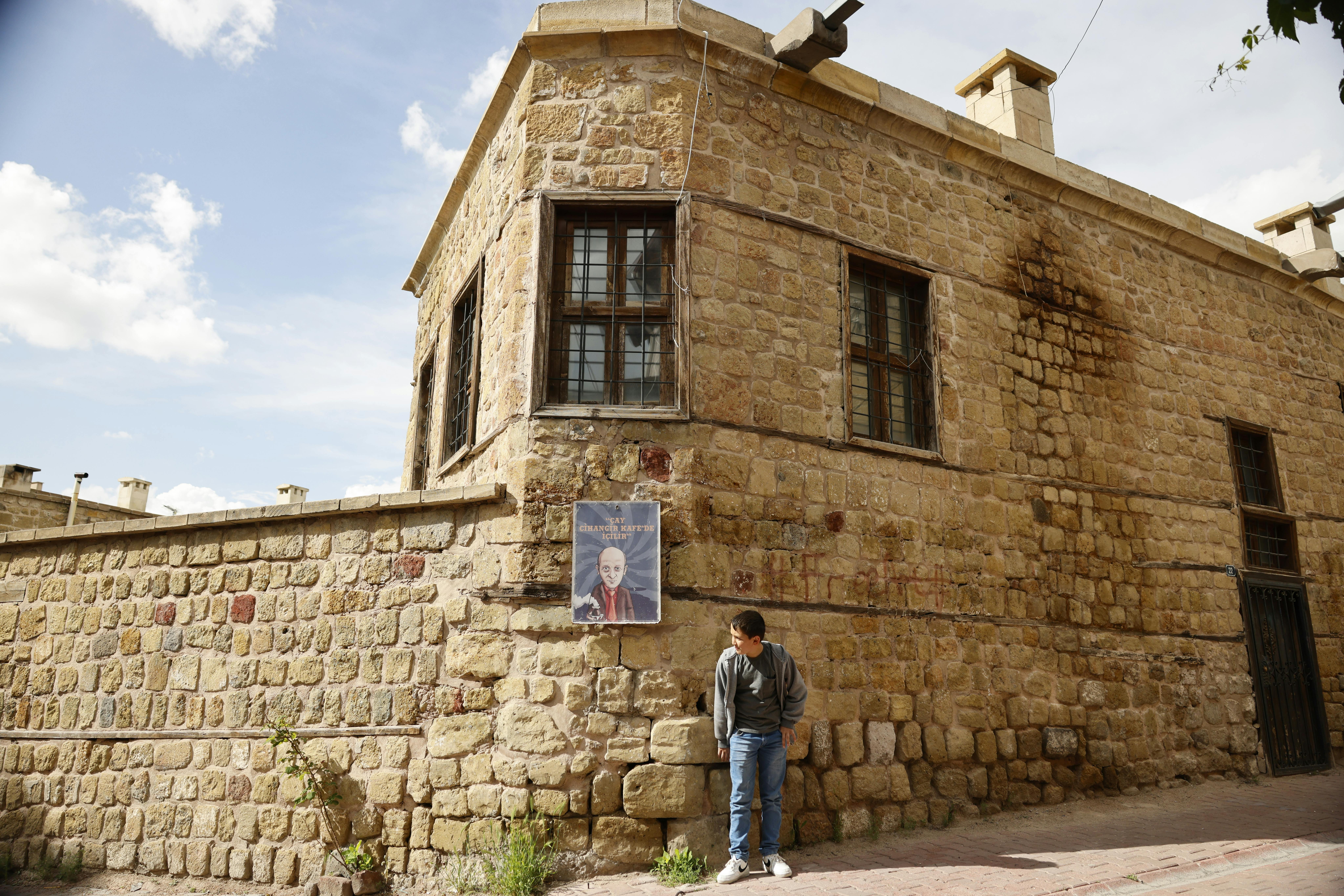 Man Standing near Stone Building Wall · Free Stock Photo