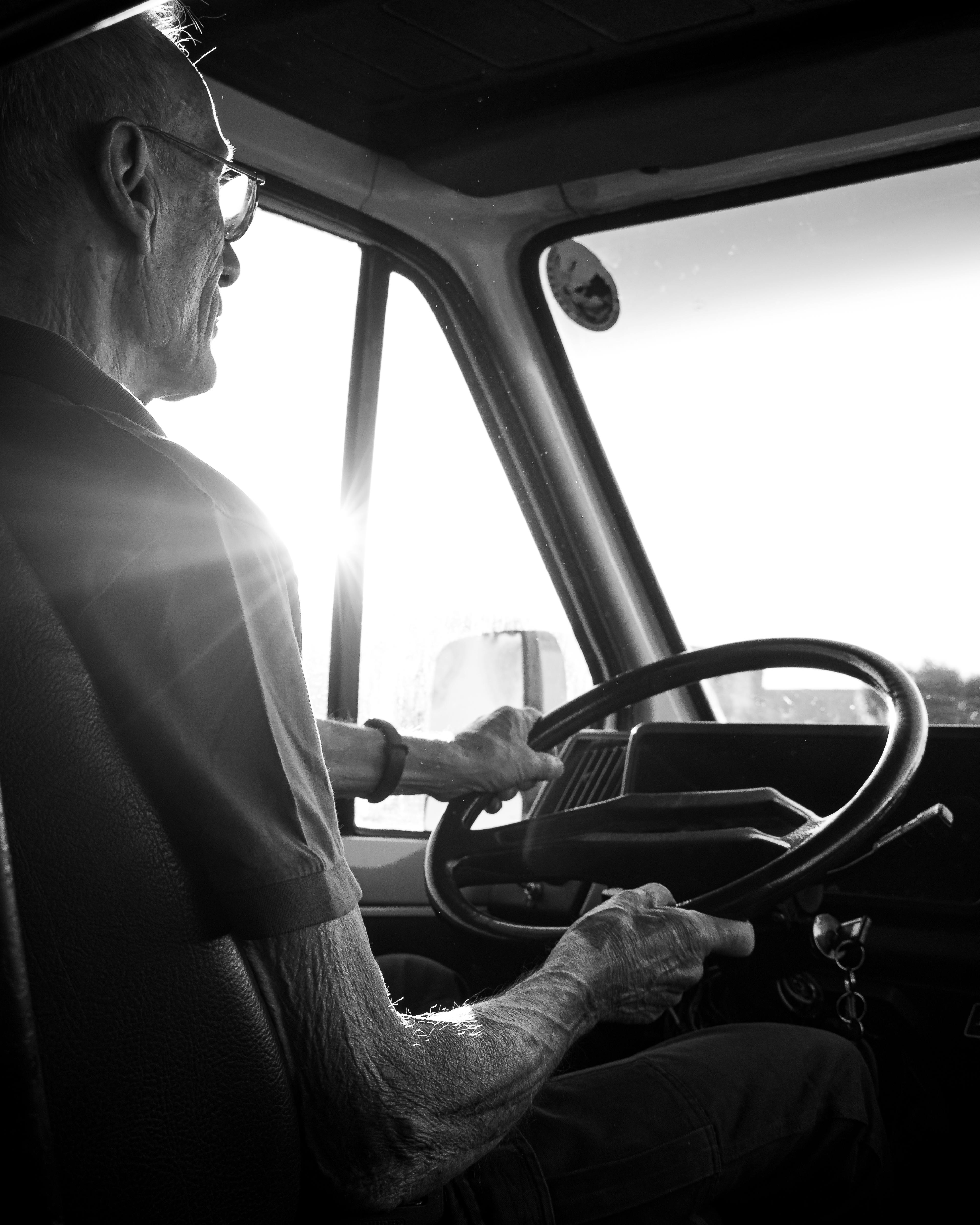 Man Driving Car in Black and White · Free Stock Photo