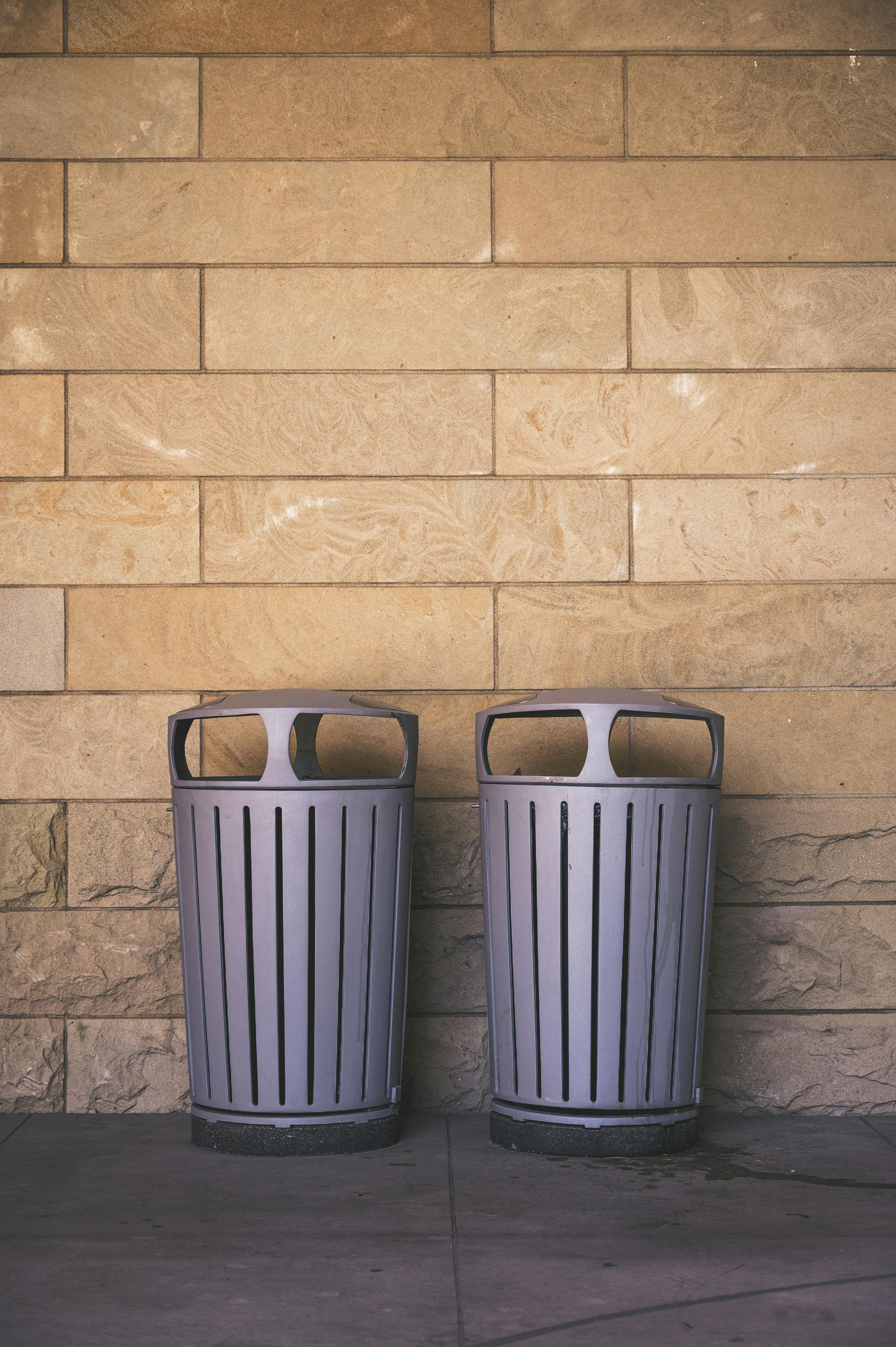 Garbage Bins under Wall · Free Stock Photo