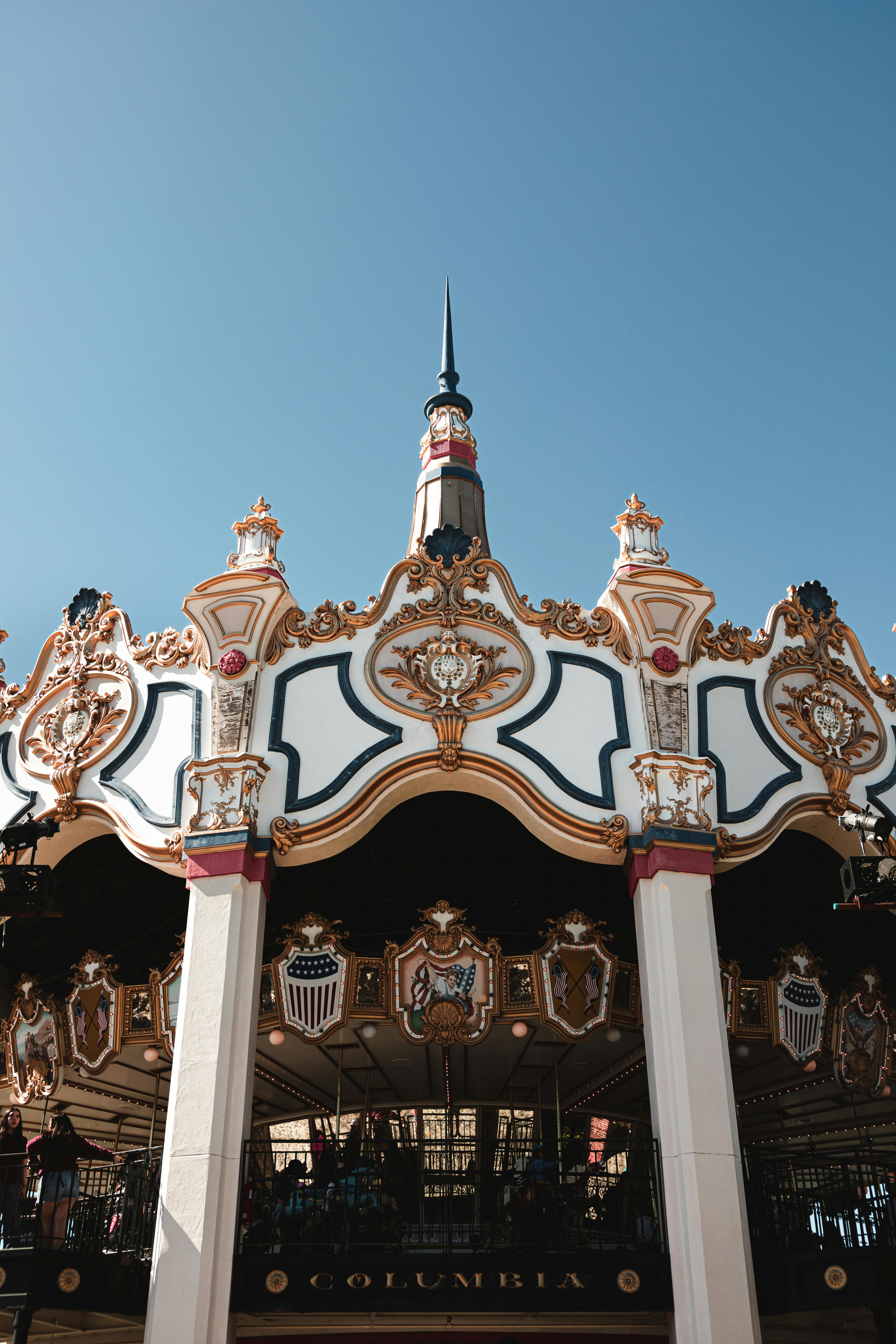 A carousel with ornate carvings on it · Free Stock Photo