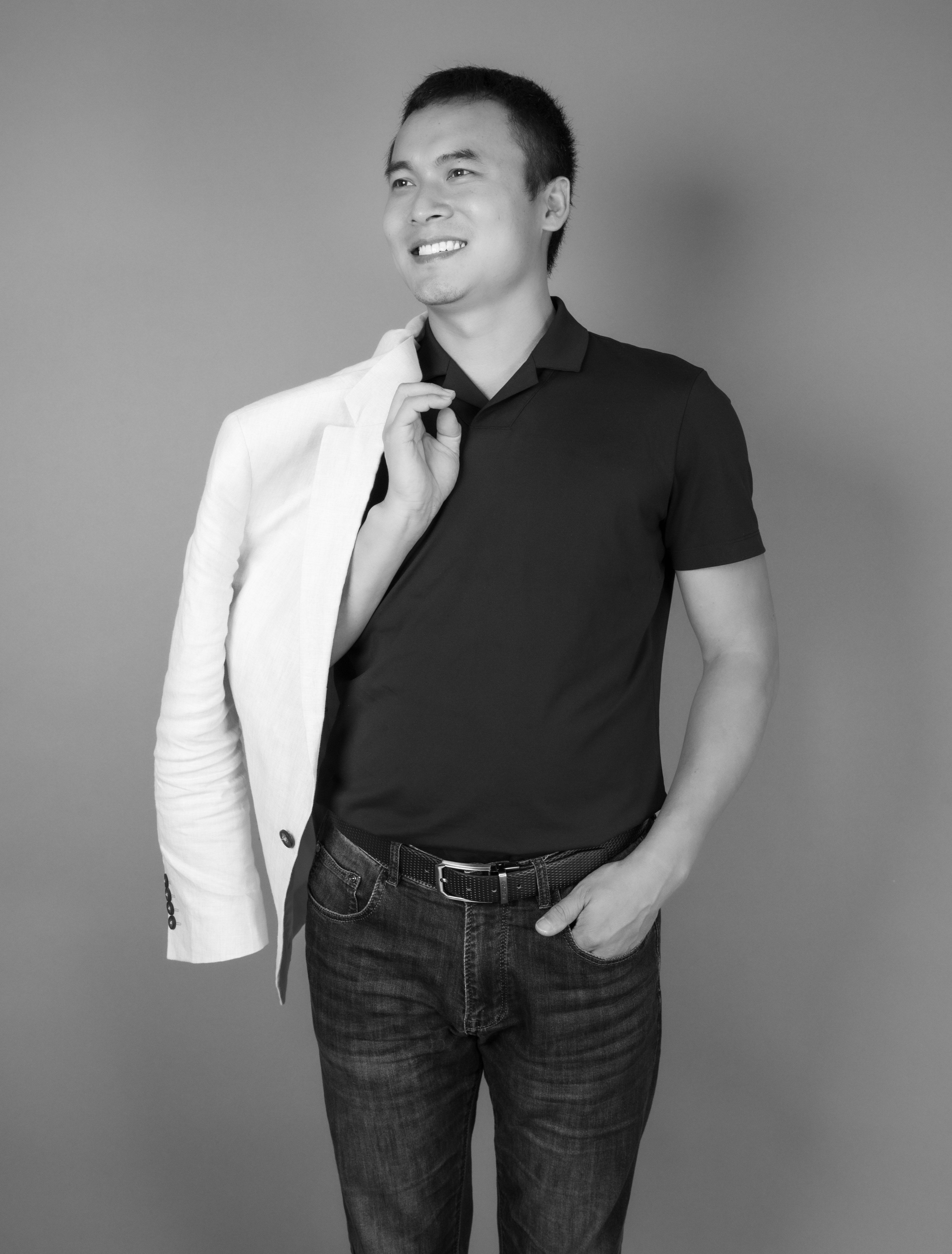 Studio Portrait of a Male Model Posing with a Jacket in Hand · Free ...