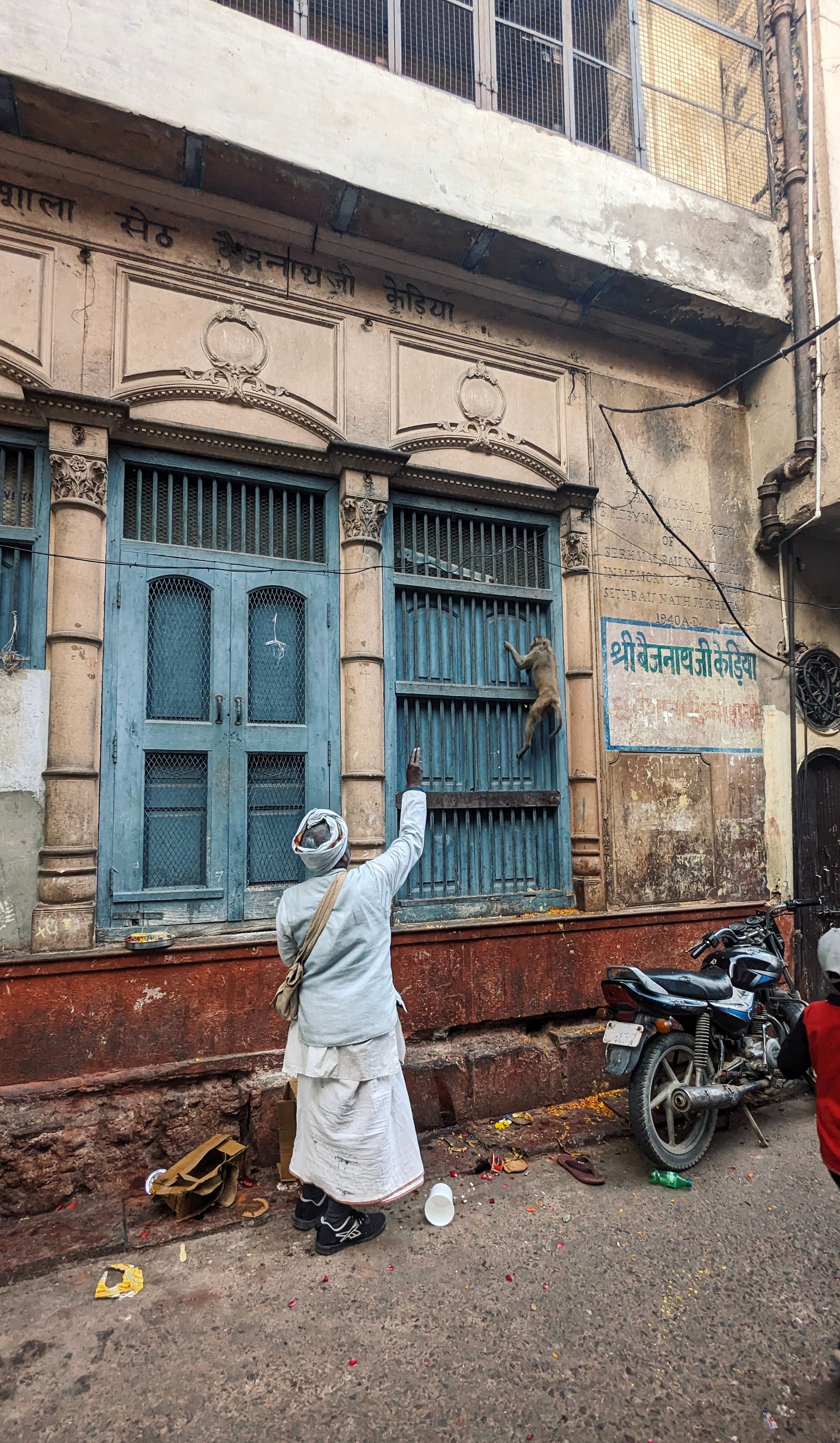 Man Standing by Monkey on Wall of Building in City · Free Stock Photo