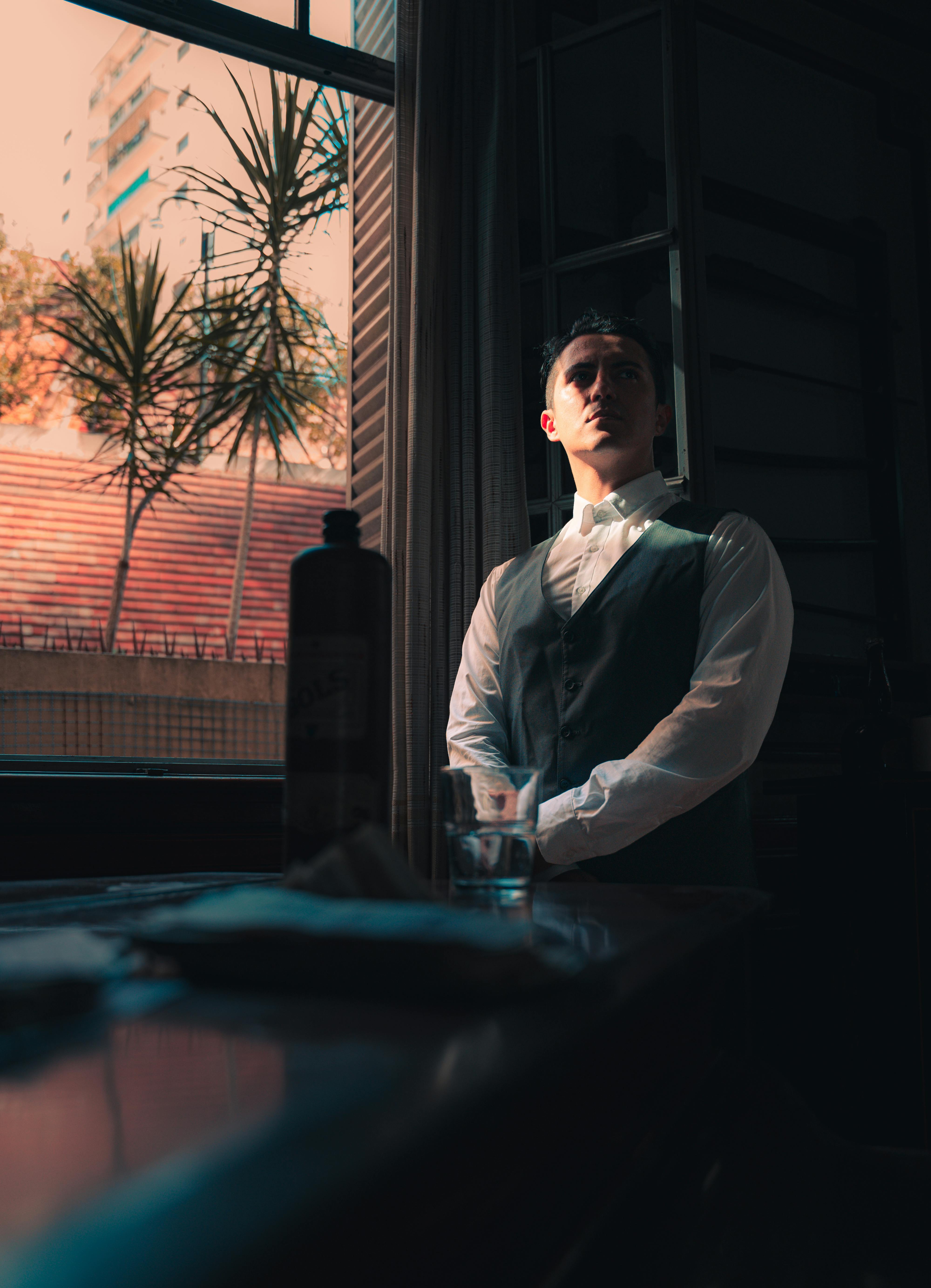 Elegant Man Standing by Window in Dark Room · Free Stock Photo