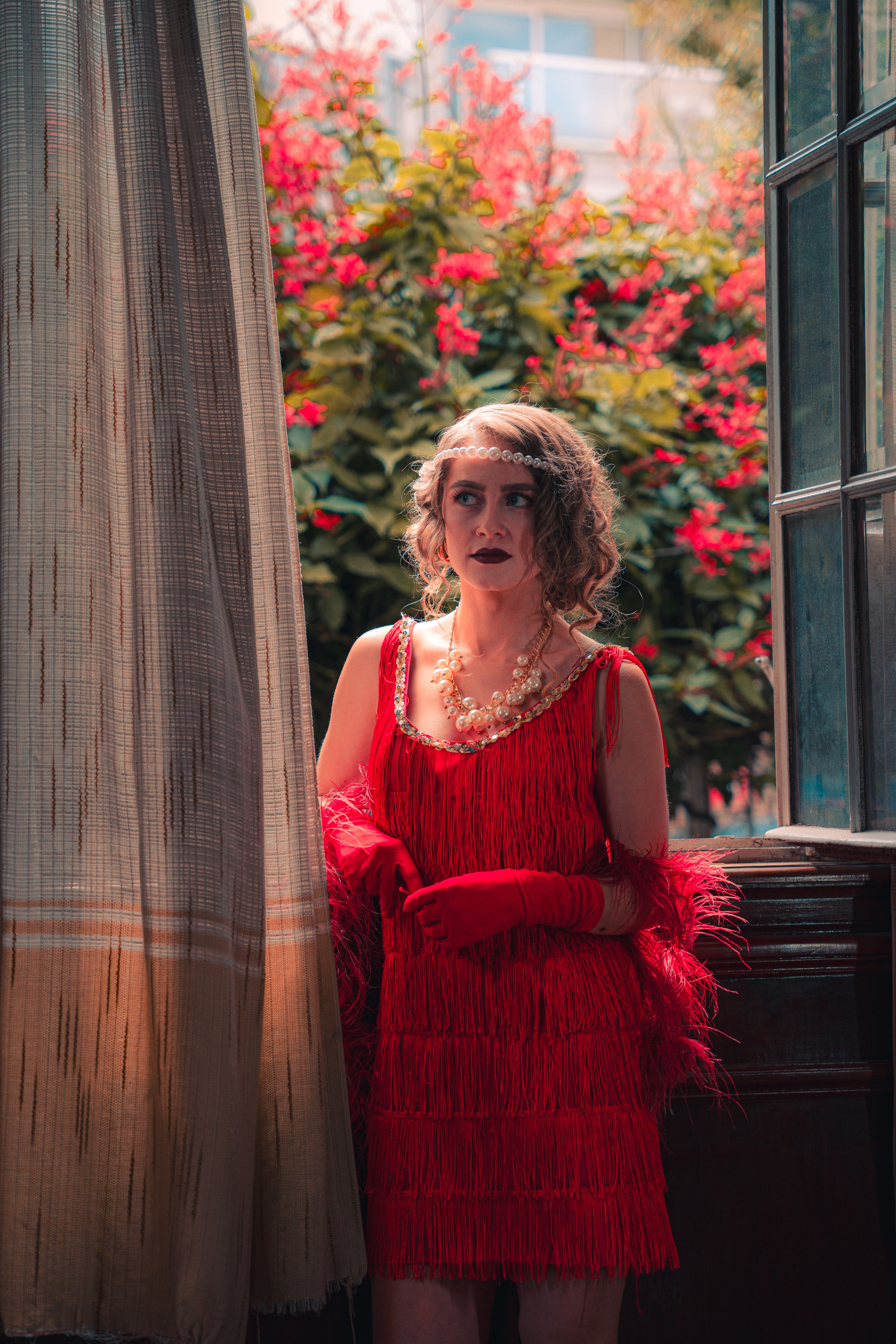 Actress in Red Flapper Dress by the Window · Free Stock Photo