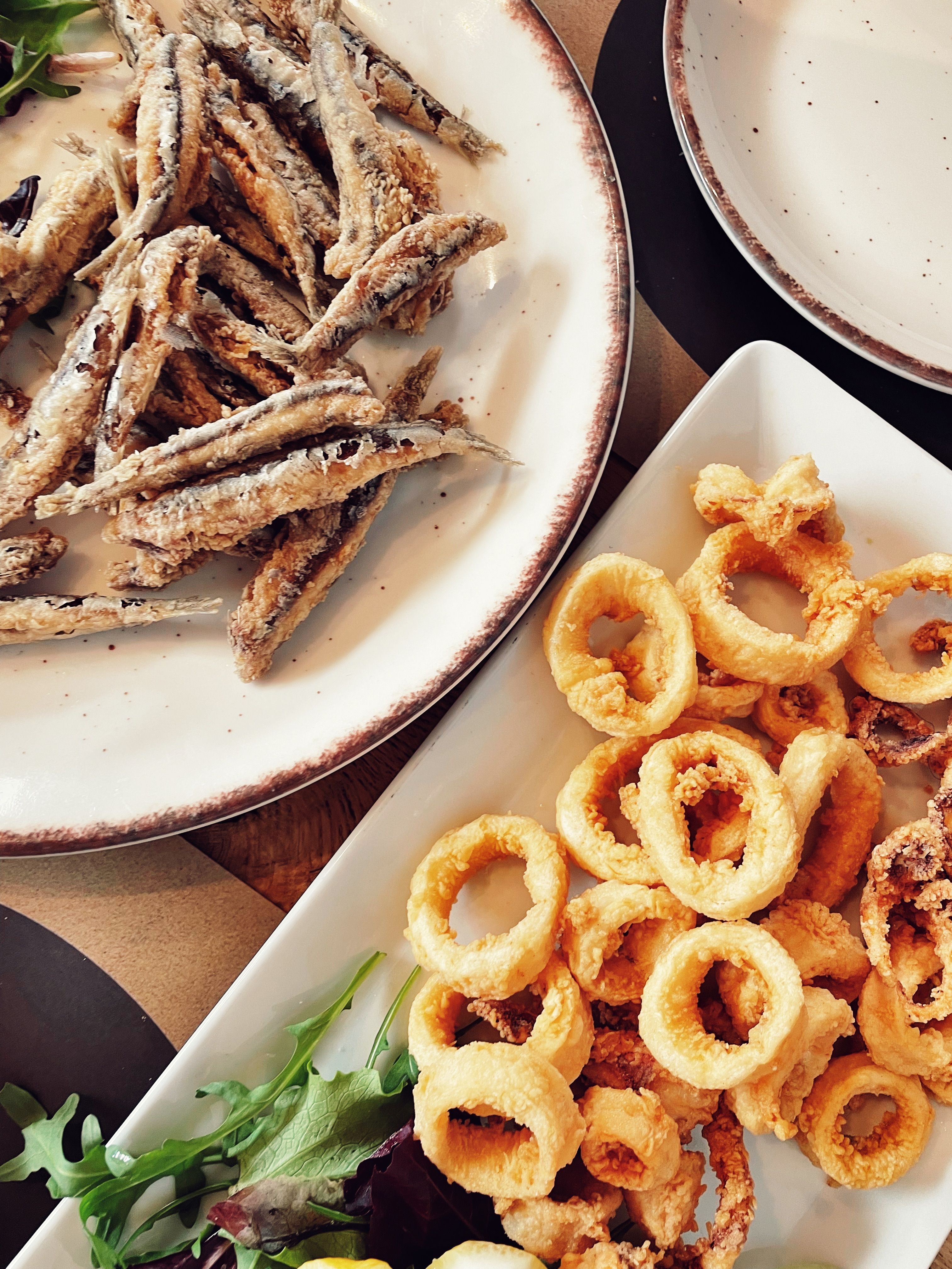 Onion Rings and Fried Anchovy Served on Plates · Free Stock Photo