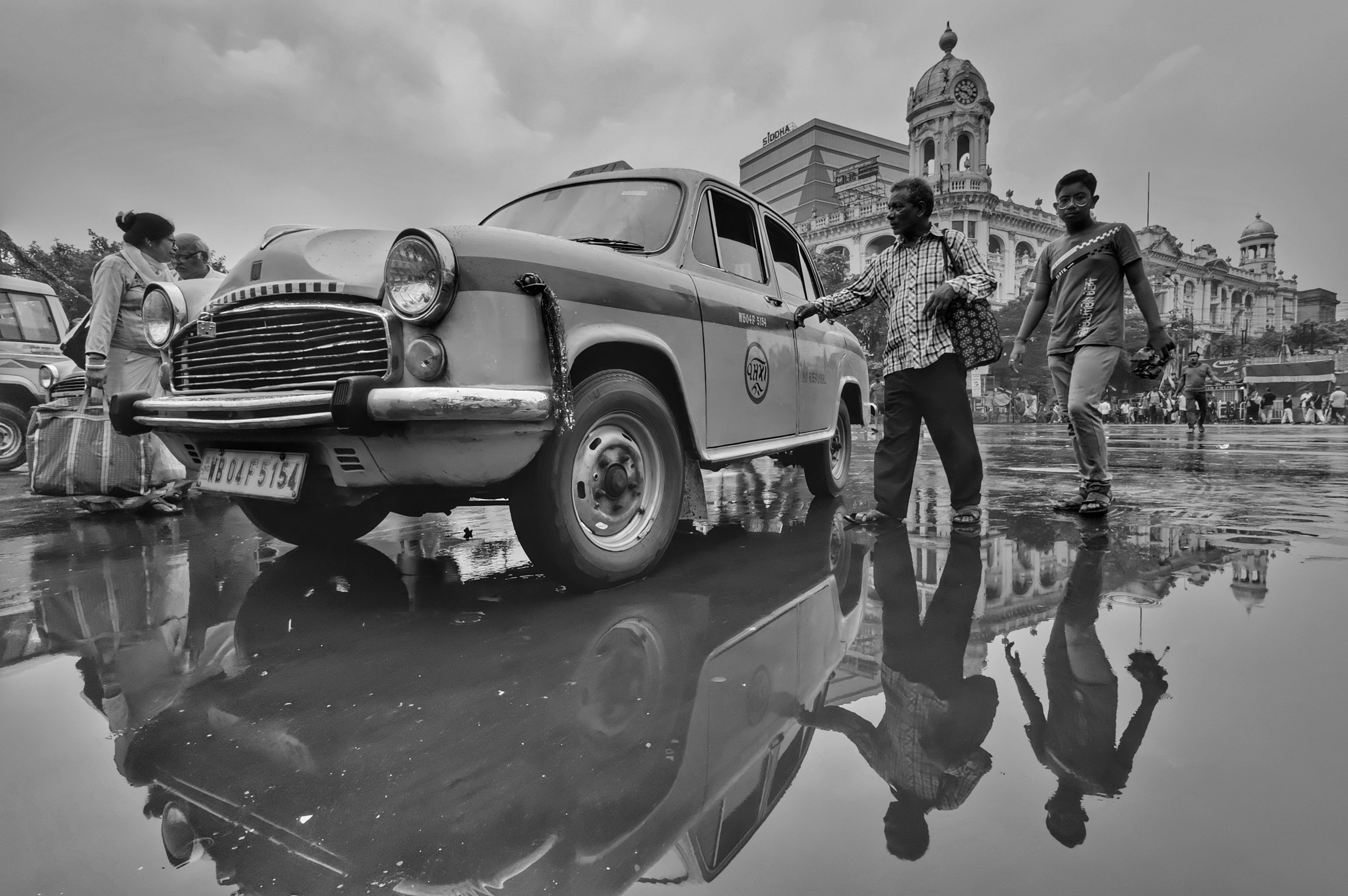 A Vintage Taxi and People on the Street in Front of the Metropolitan ...