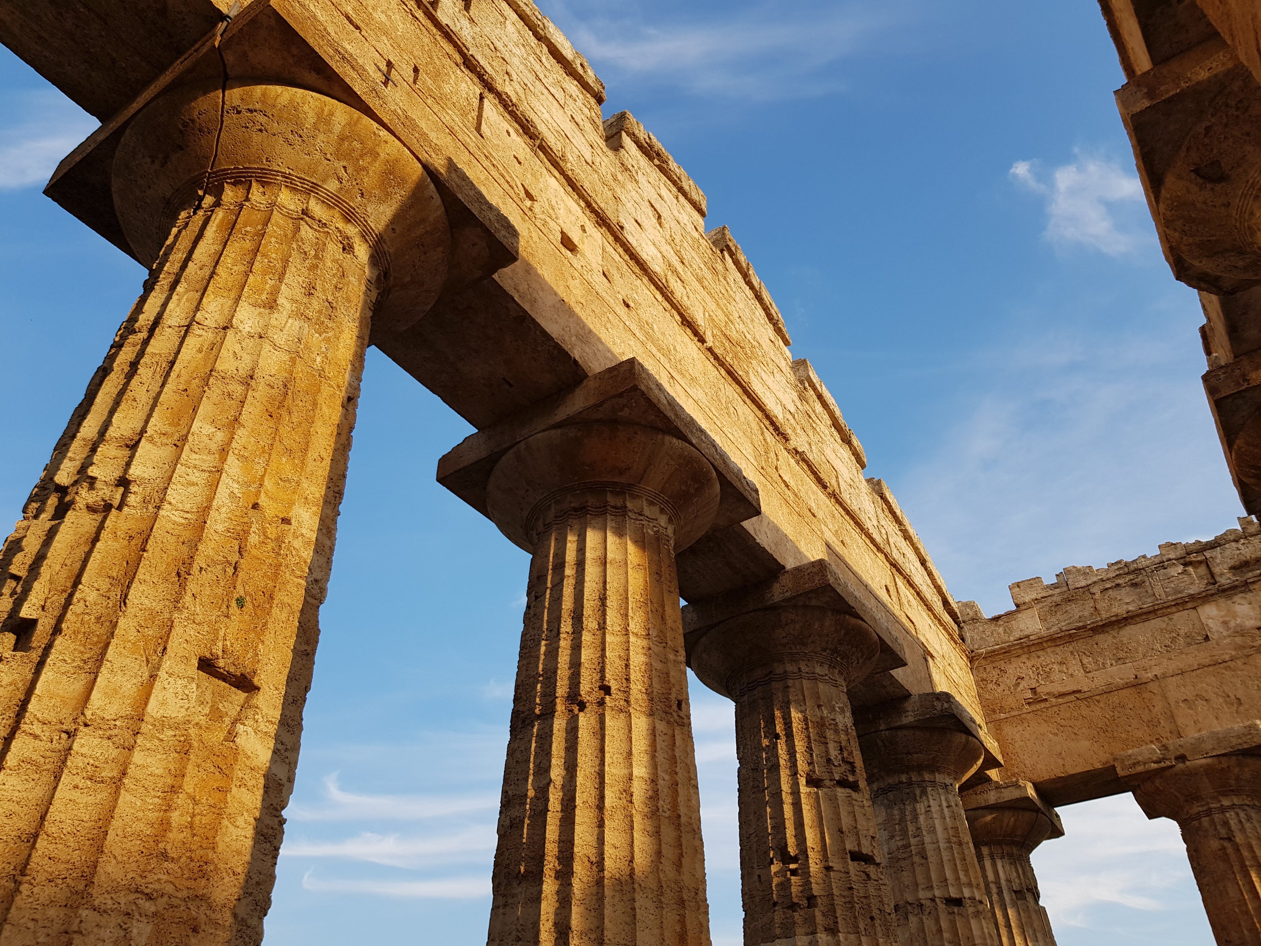 The columns of an ancient temple are shown · Free Stock Photo