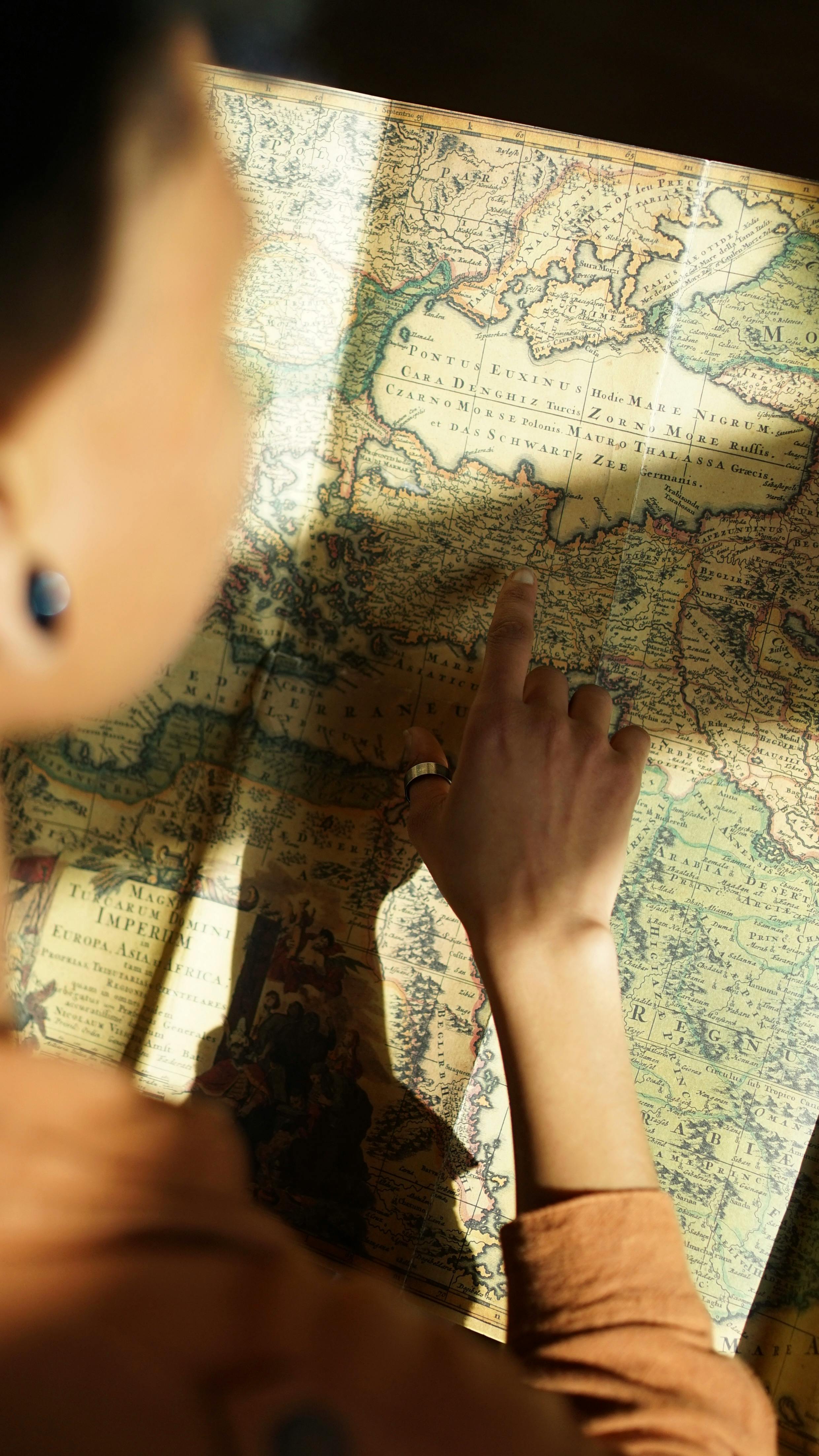 Woman Hand on Map · Free Stock Photo